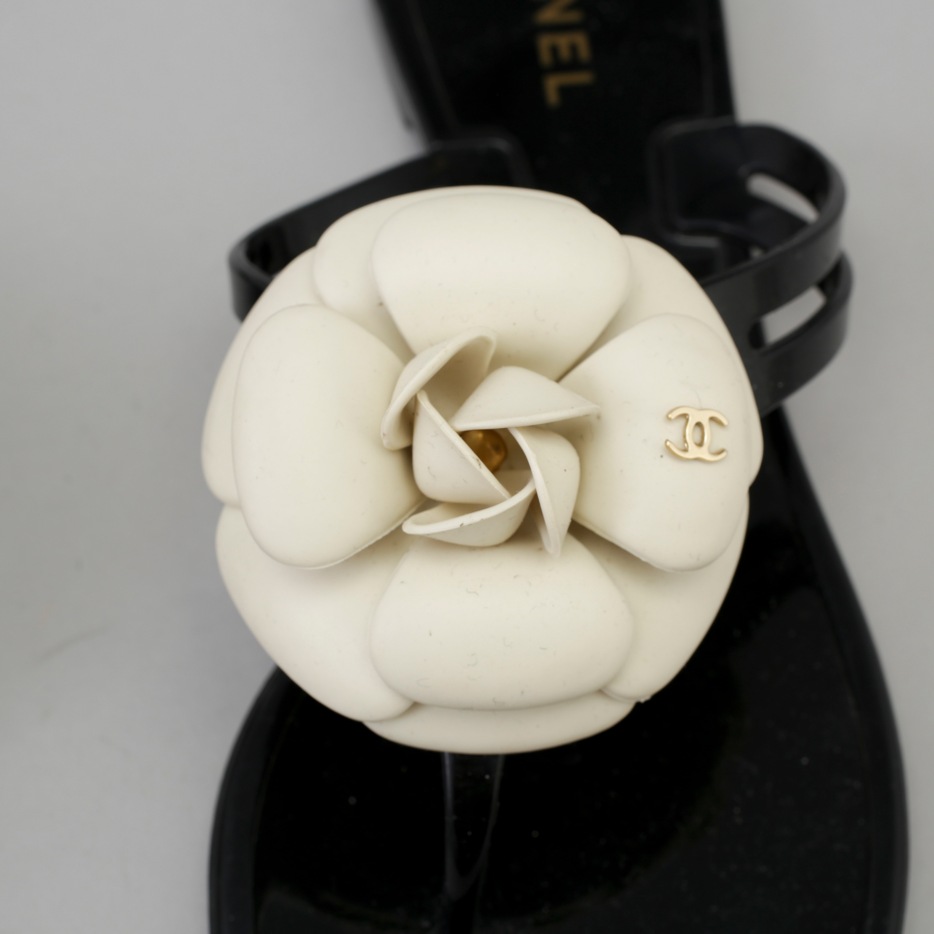 CHANEL, a pair of black plastic sandals. Size 38. - Bukowskis