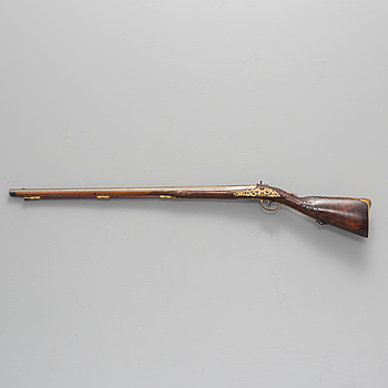 A 18th century walnut rifle, converted from flintlock to a percussion ...