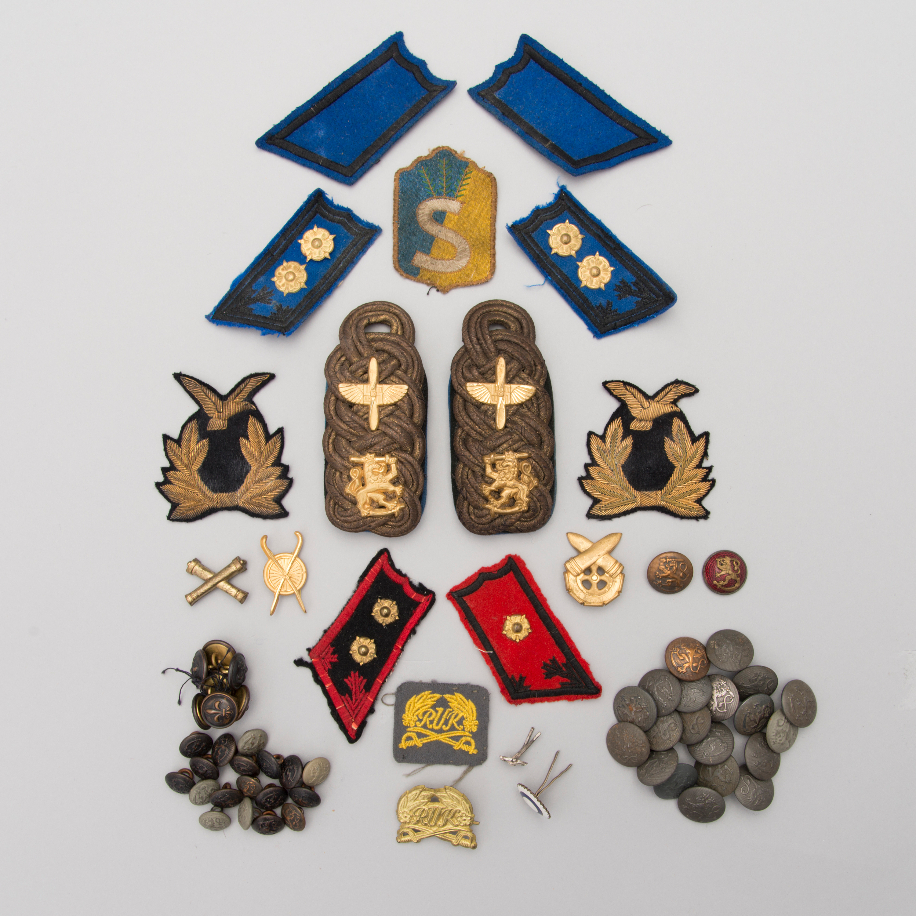 A set of Finnish military epaulets, insignia and buttons, circa 65 pcs ...