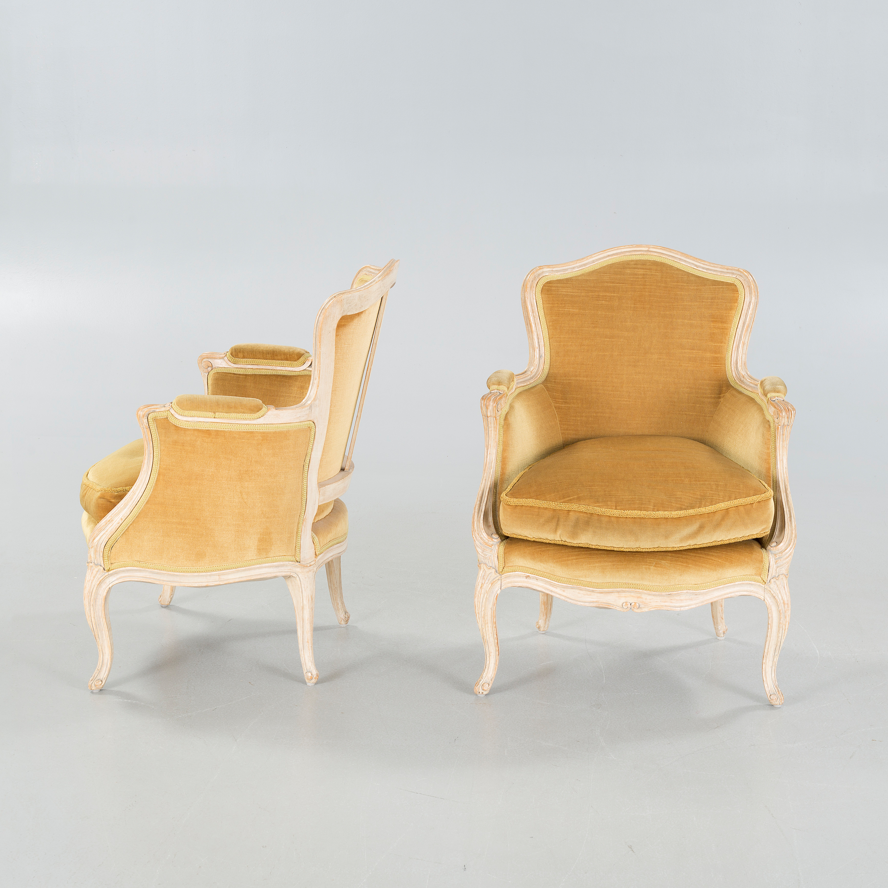 A pair of rococo style lounge chairs, first half of the 20th century ...