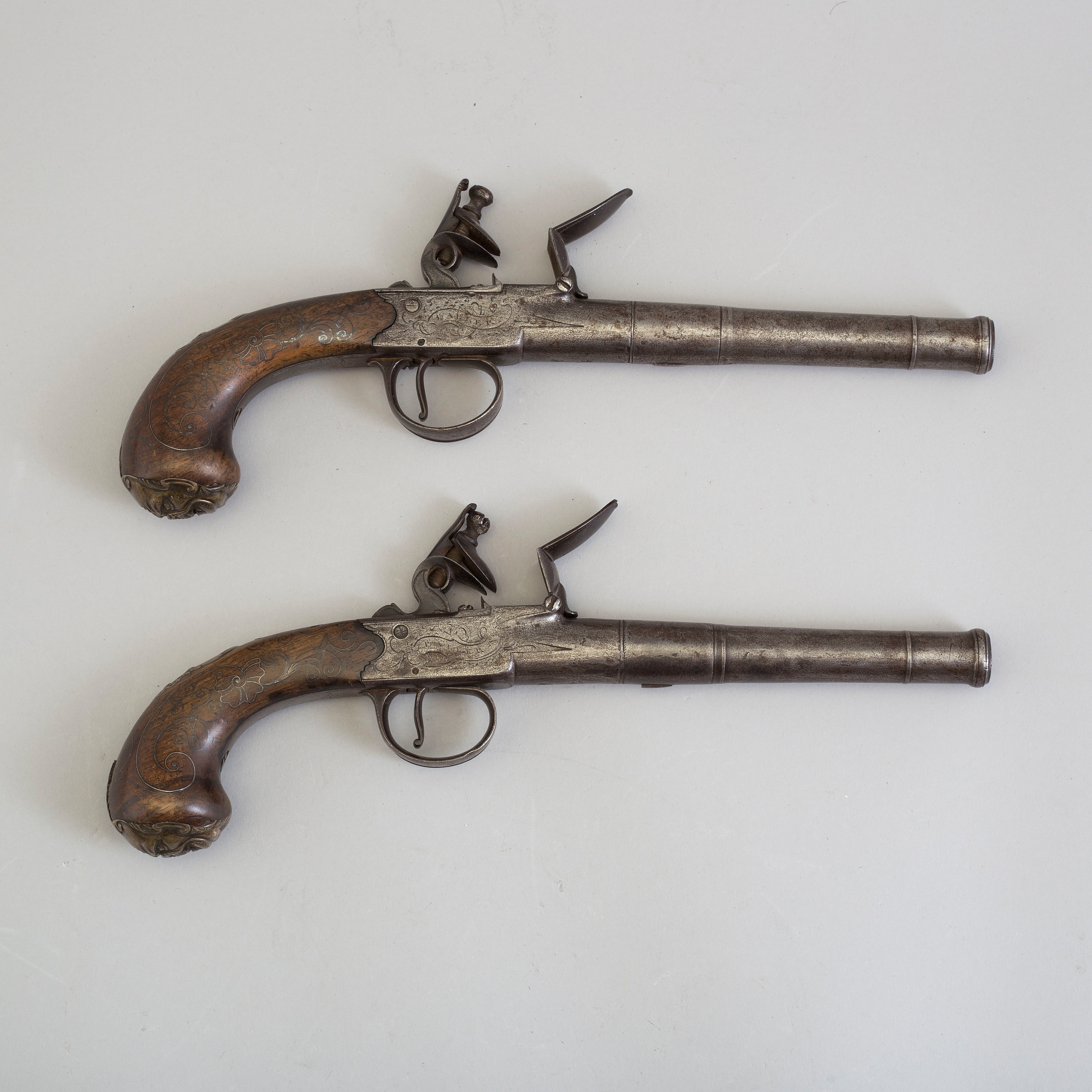 A pair of Queen Anne flintlock pistols makers mark Barker and London ...