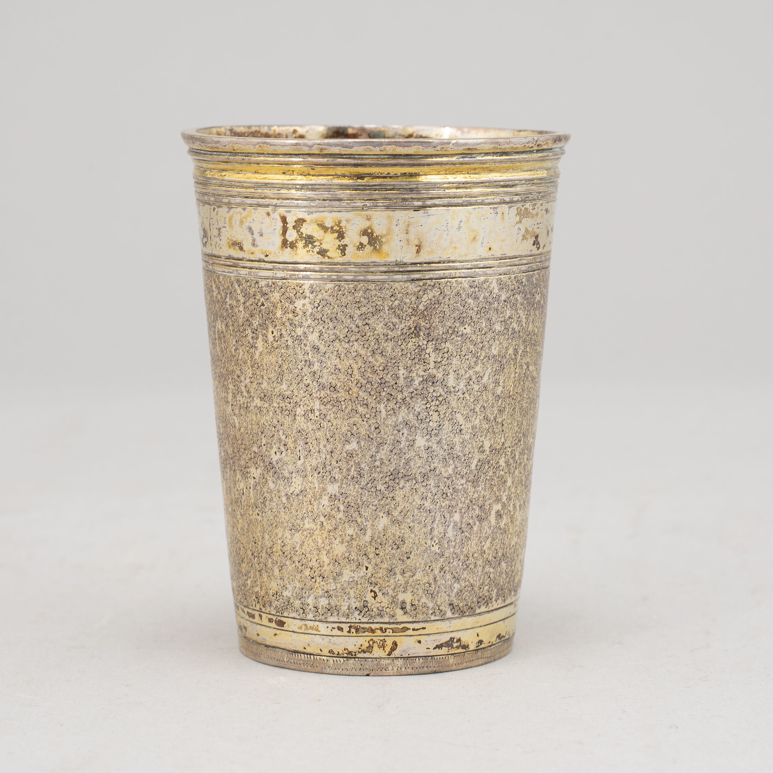 A German 17th century parcel-gilt silver beaker, unmarked. With later ...