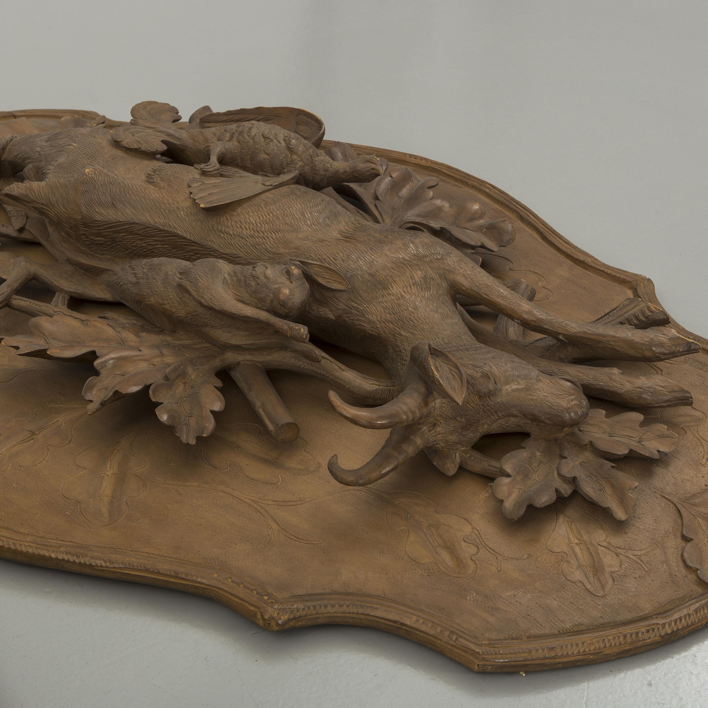 A pair of relief hunting still lives, wood carving, turn of the century ...