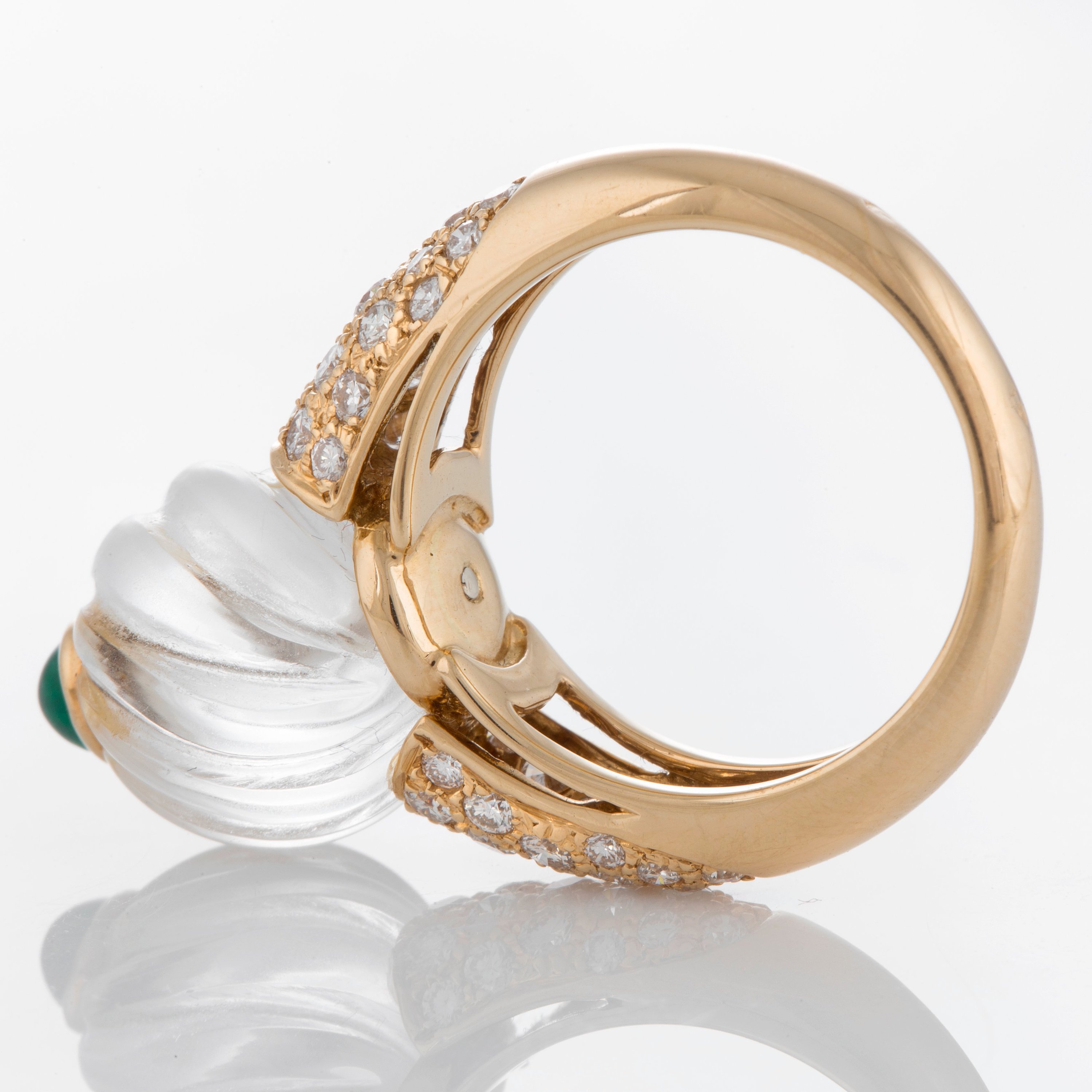 A Boucheron ring set with a carved rock crystal, a cabochon-cut emerald ...