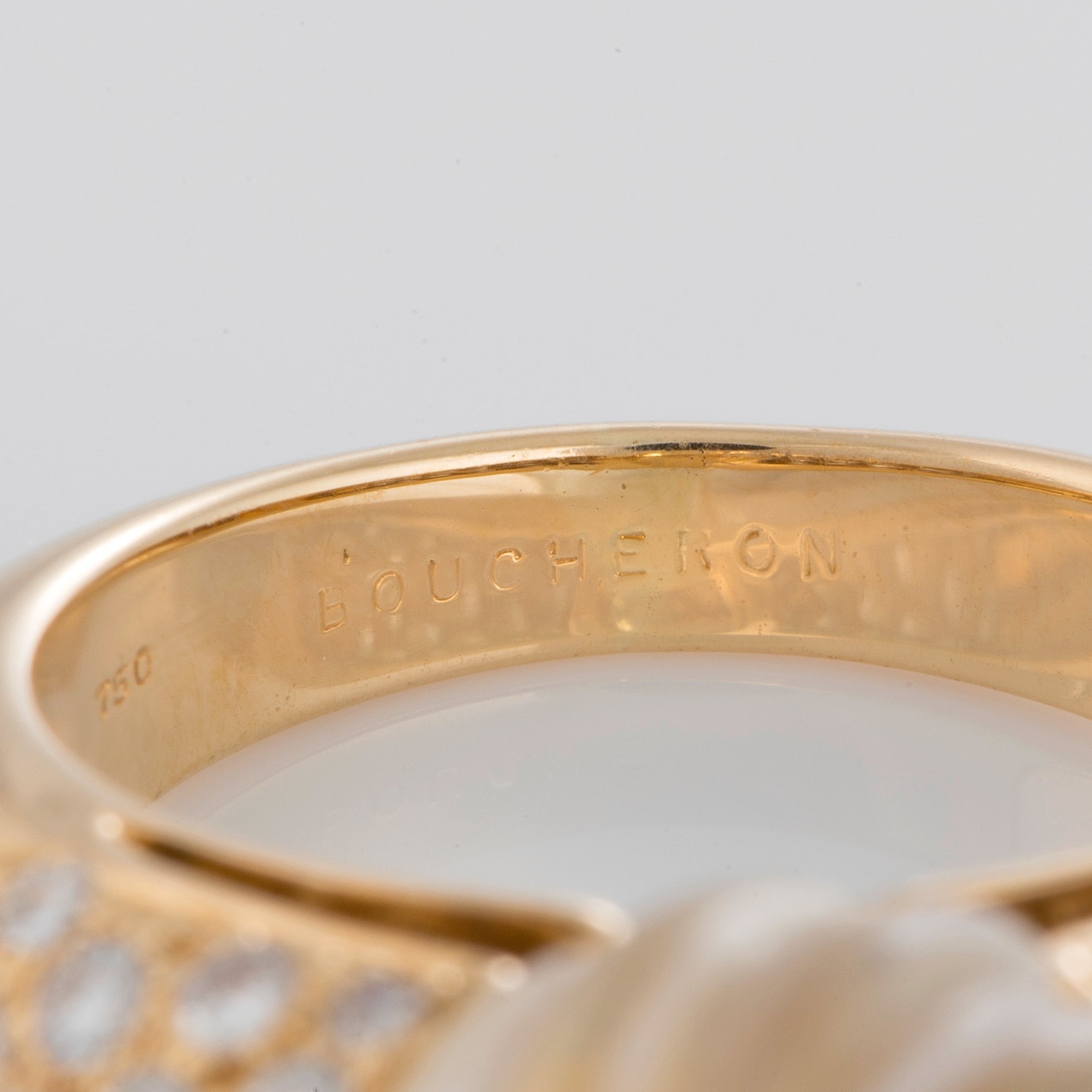 A Boucheron ring set with a carved rock crystal, a cabochon-cut emerald ...