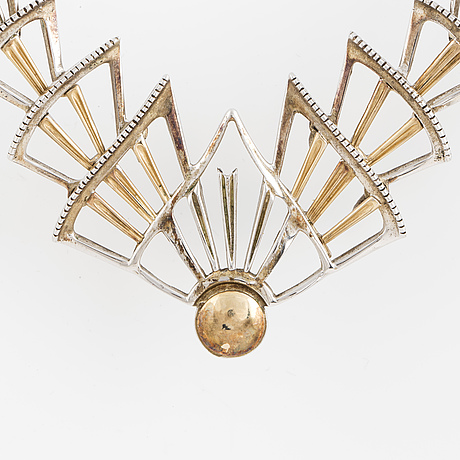 An ERTE necklace with a detachable pendant wearble as a brooch. - Bukowskis