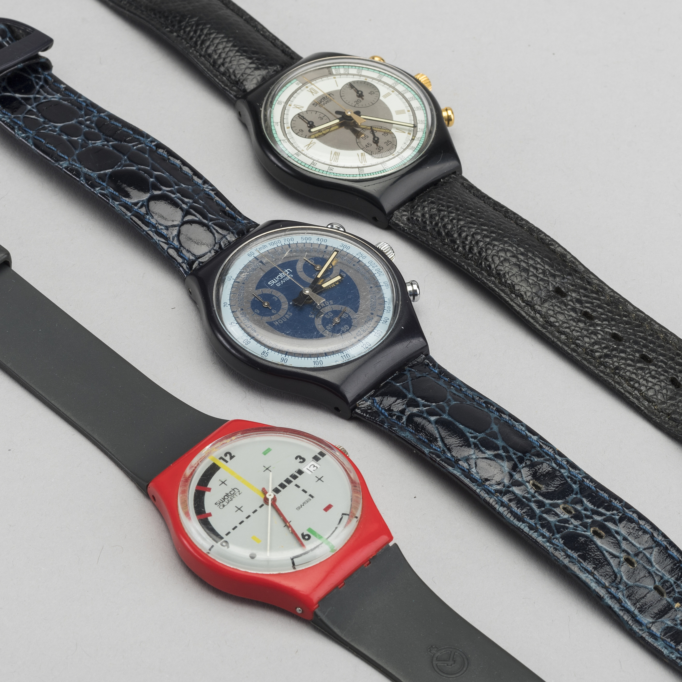 Three watches and one book by Swatch. - Bukowskis