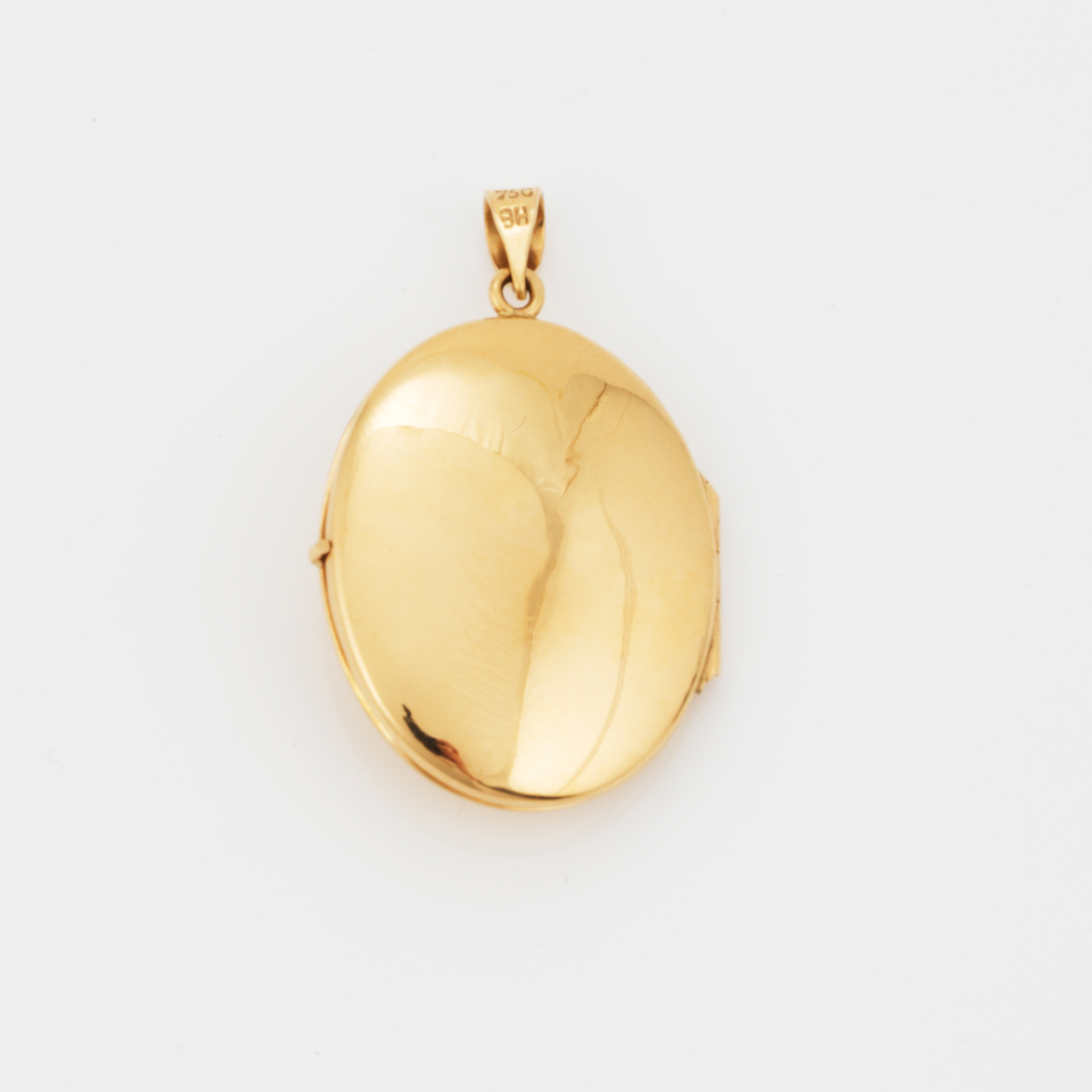 An 18K gold and diamond locket pendant. - Bukowskis