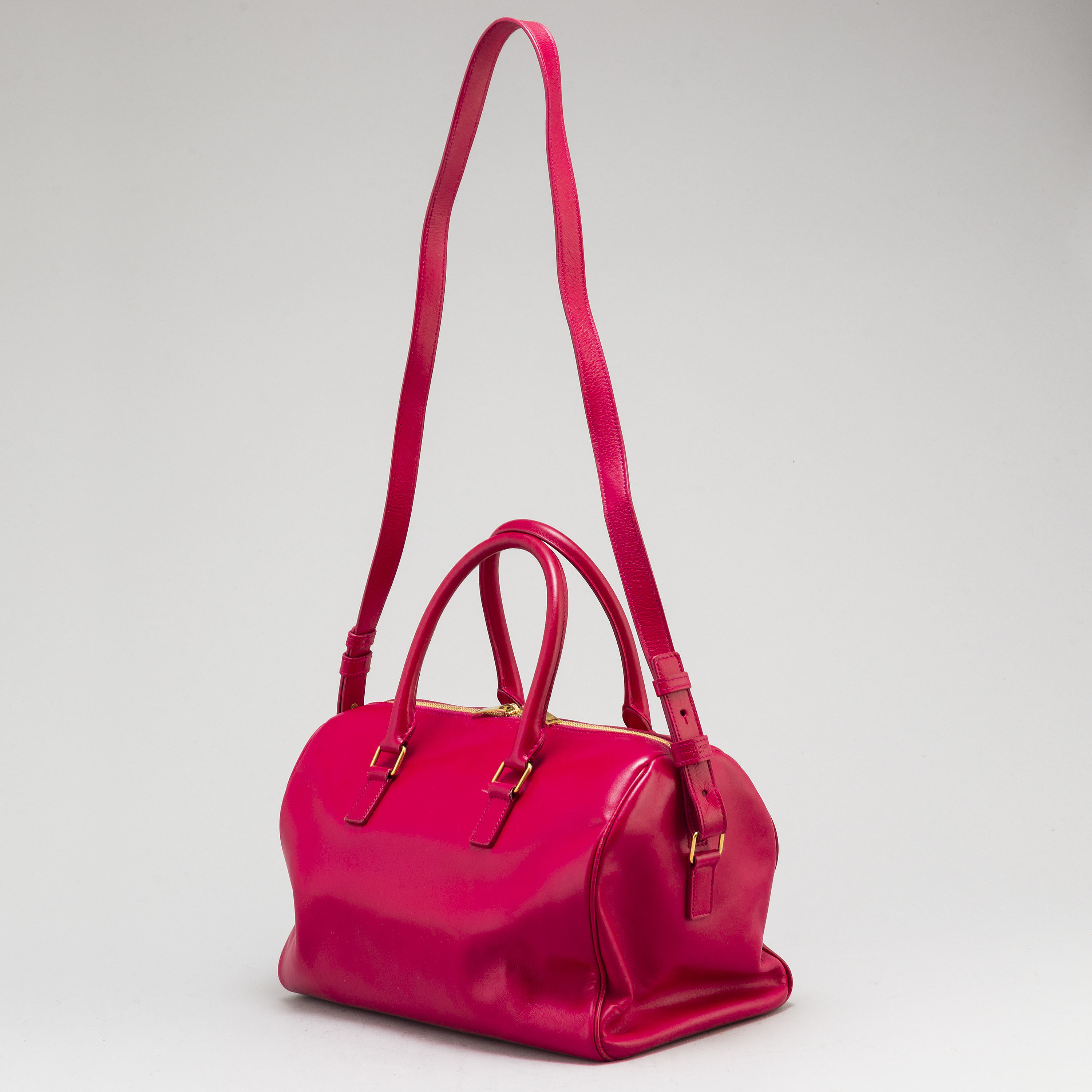 YVES SAINT LAURENT, a hot pink 'Classic duffle 6' bag. - Bukowskis