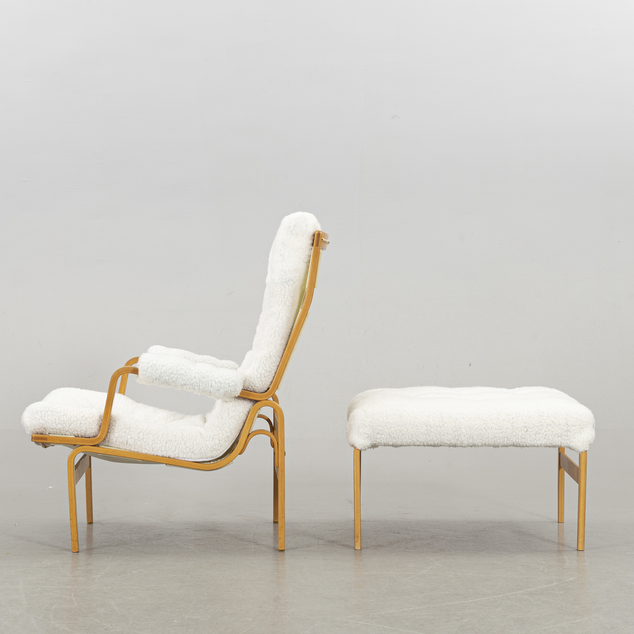 BRUNO MATHSSON, an "ingrid" armchair and stool for Dux. Late 20th ...