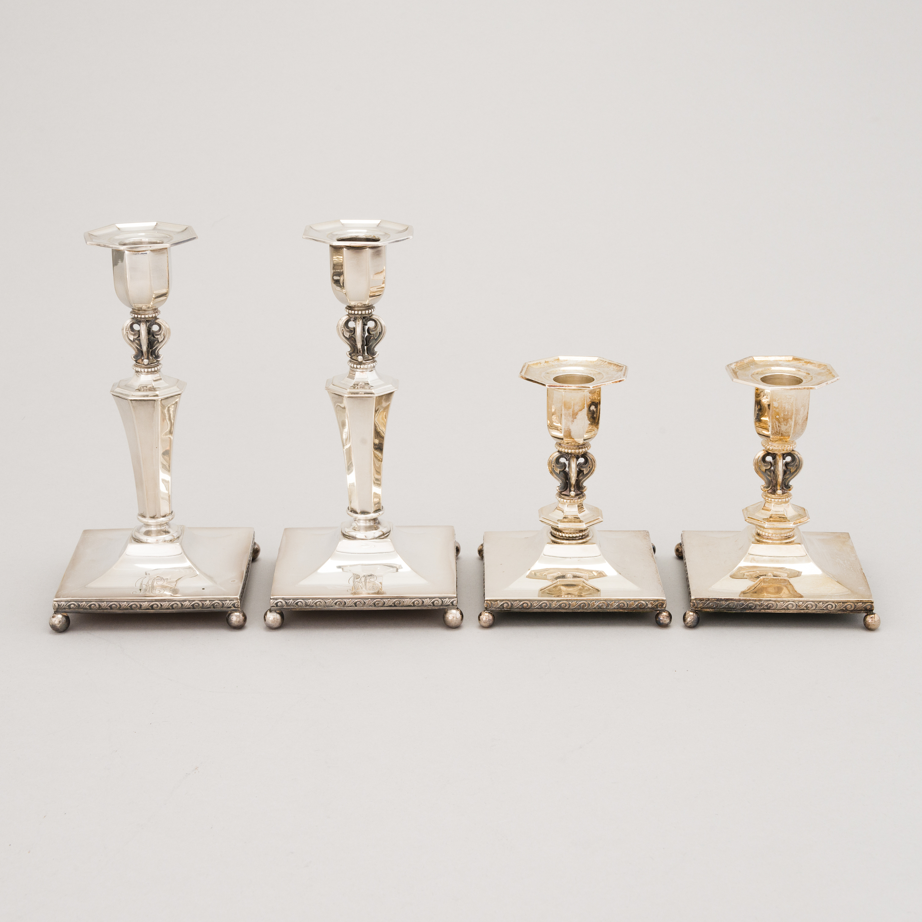 Four silver writing desk utensils and two pair of silver candlesticks ...