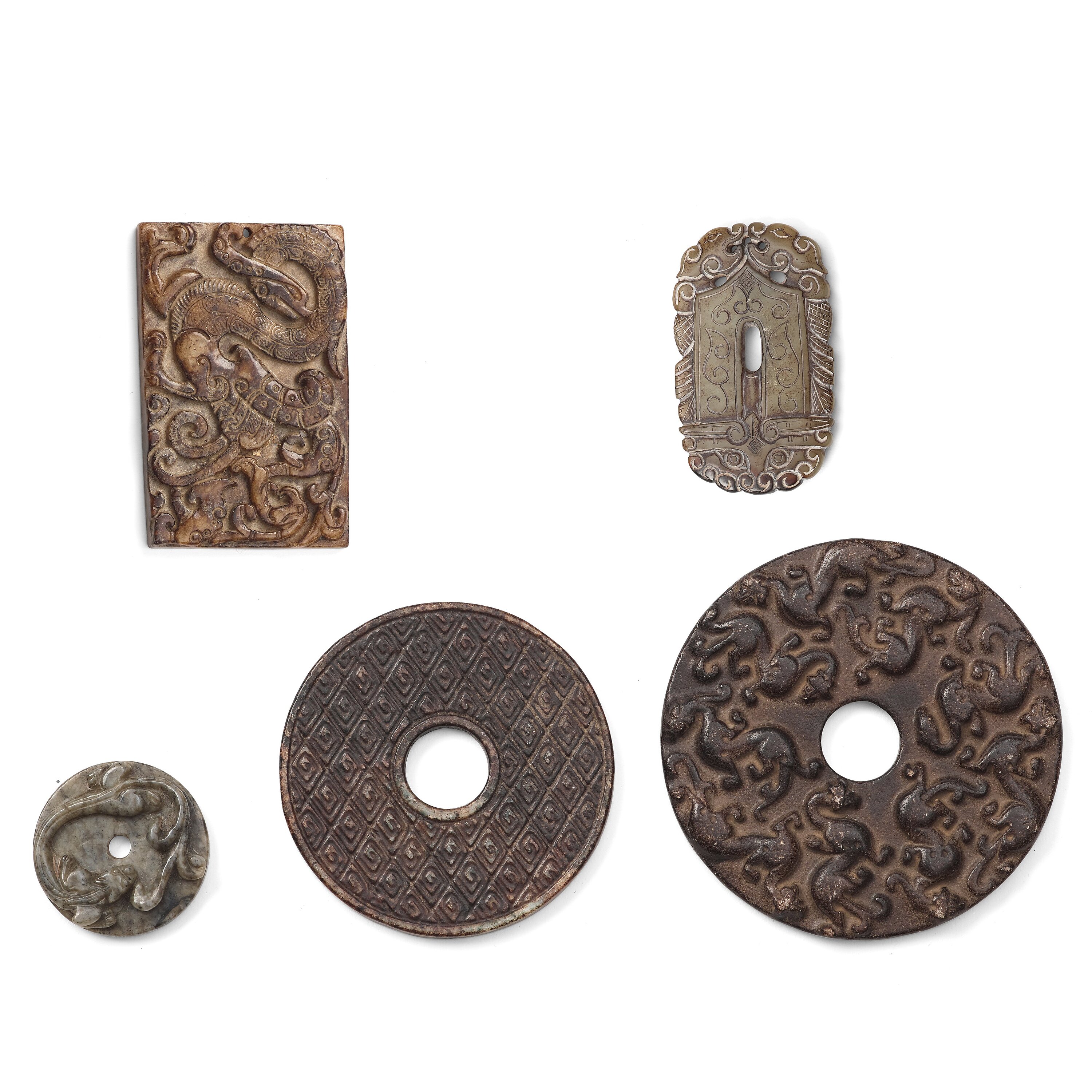 A group of three archaistic Chinese stone bi discs and two pendants ...