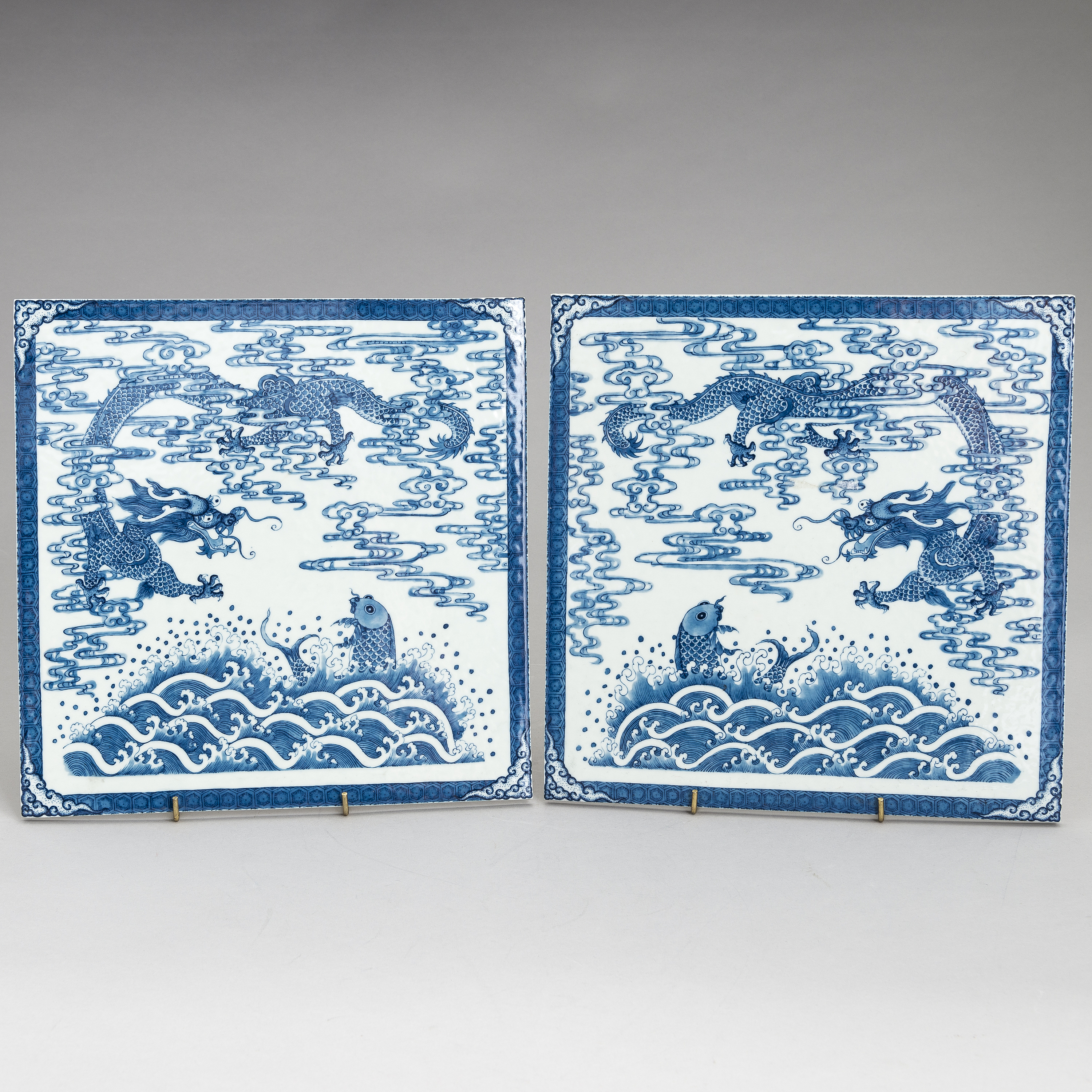 A pair of Chinese ceramic wall tiles, 20th Century. - Bukowskis