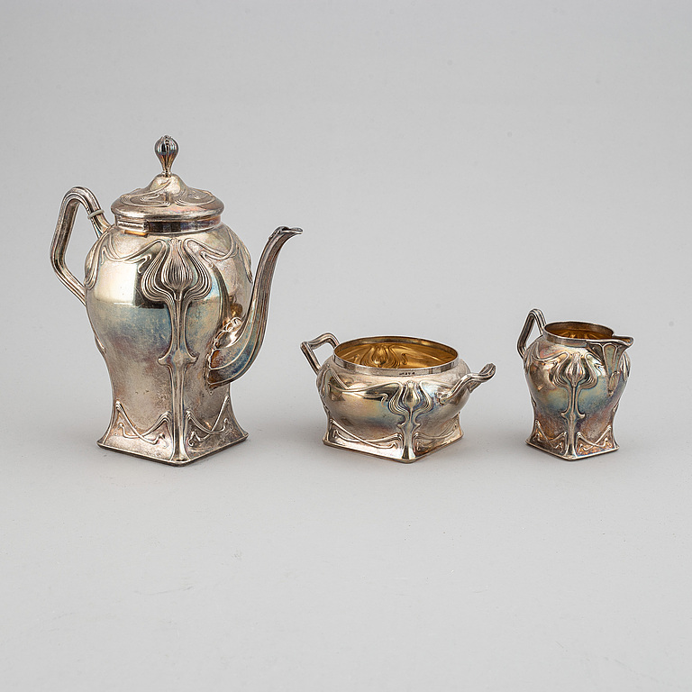 An art nouveau silver coffee pot, sugar bowl and creamer, mark of CF ...