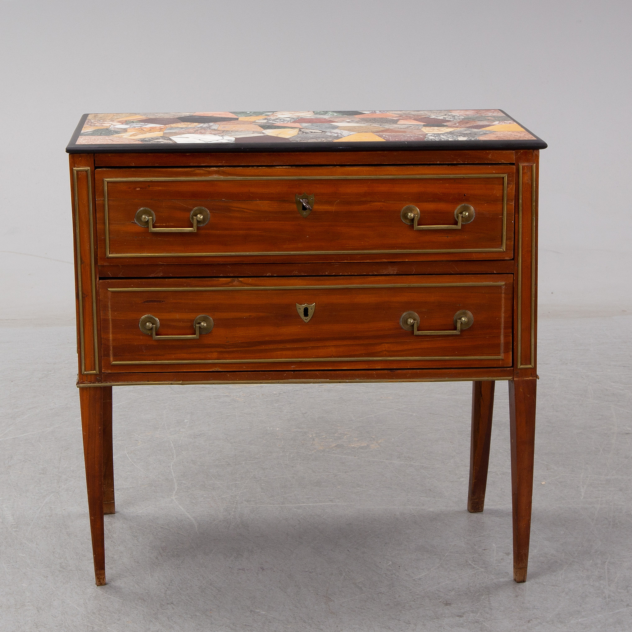 An early 19th Century mahogany veneered chest of drawers. Pietra dura top signed and dated ...