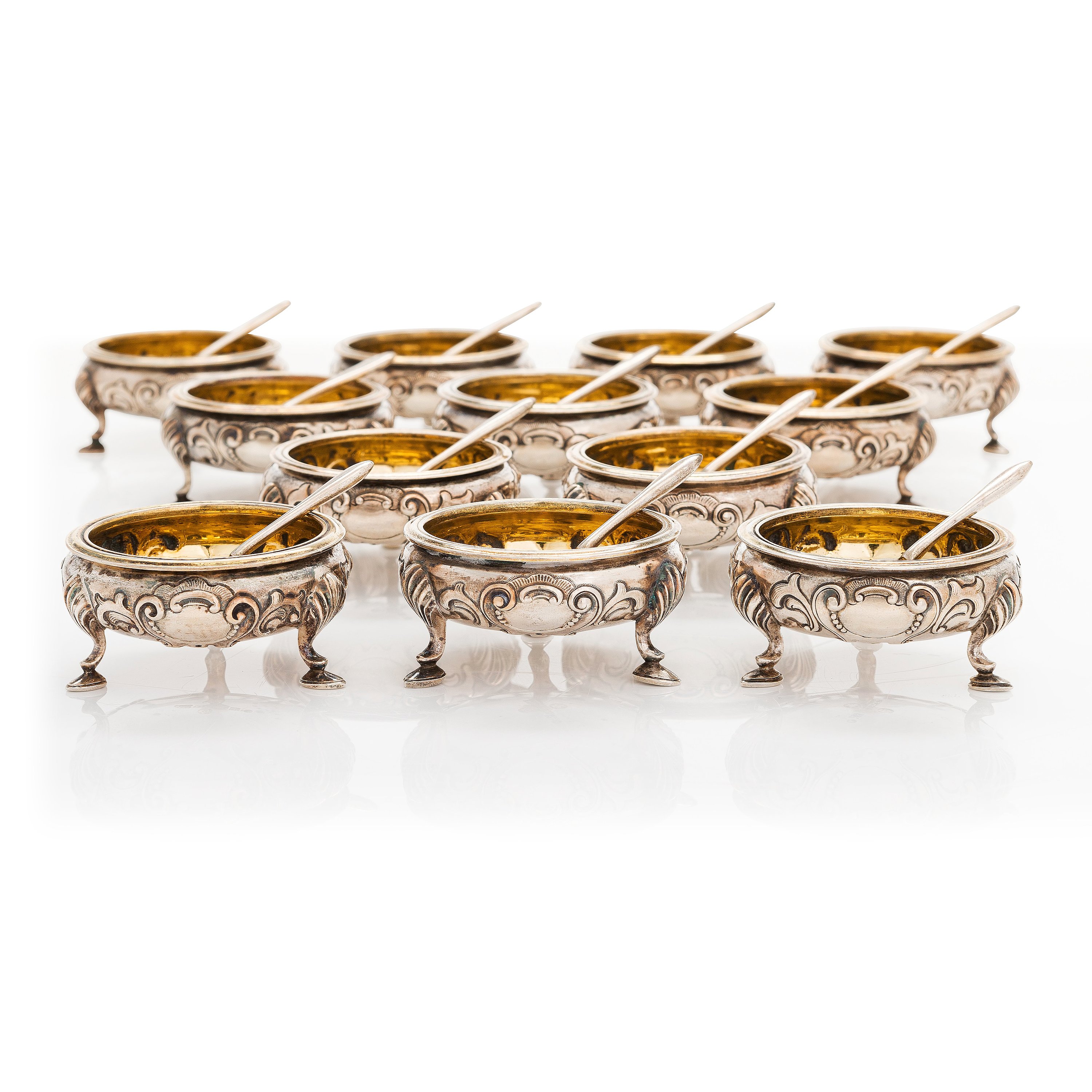 A set of 12 Russian silver salt cellars and 12 salt spoons, Sazikov ...