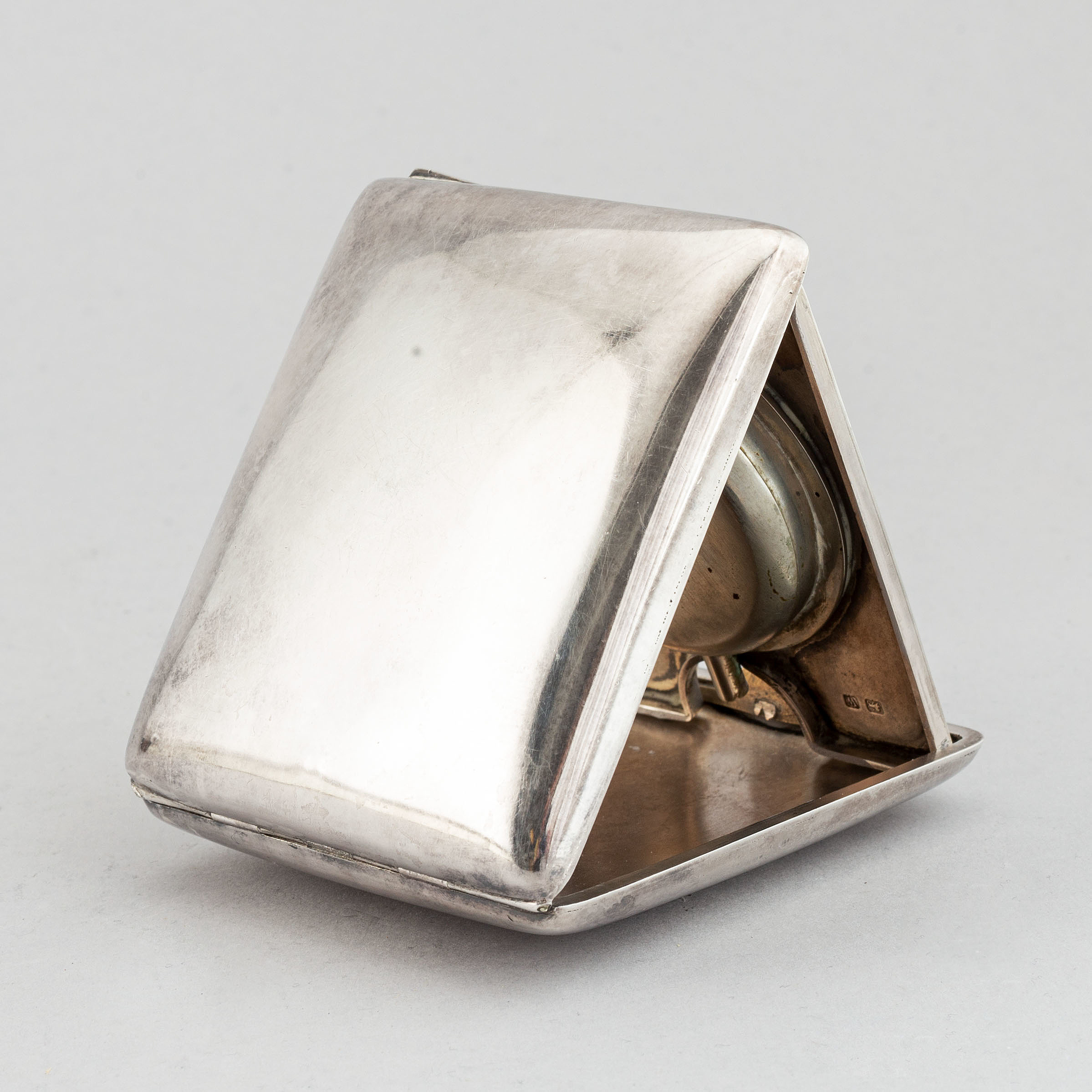 A silver travel alarm clock, makr of Hasset & Harper Ltd, Birmingham ...