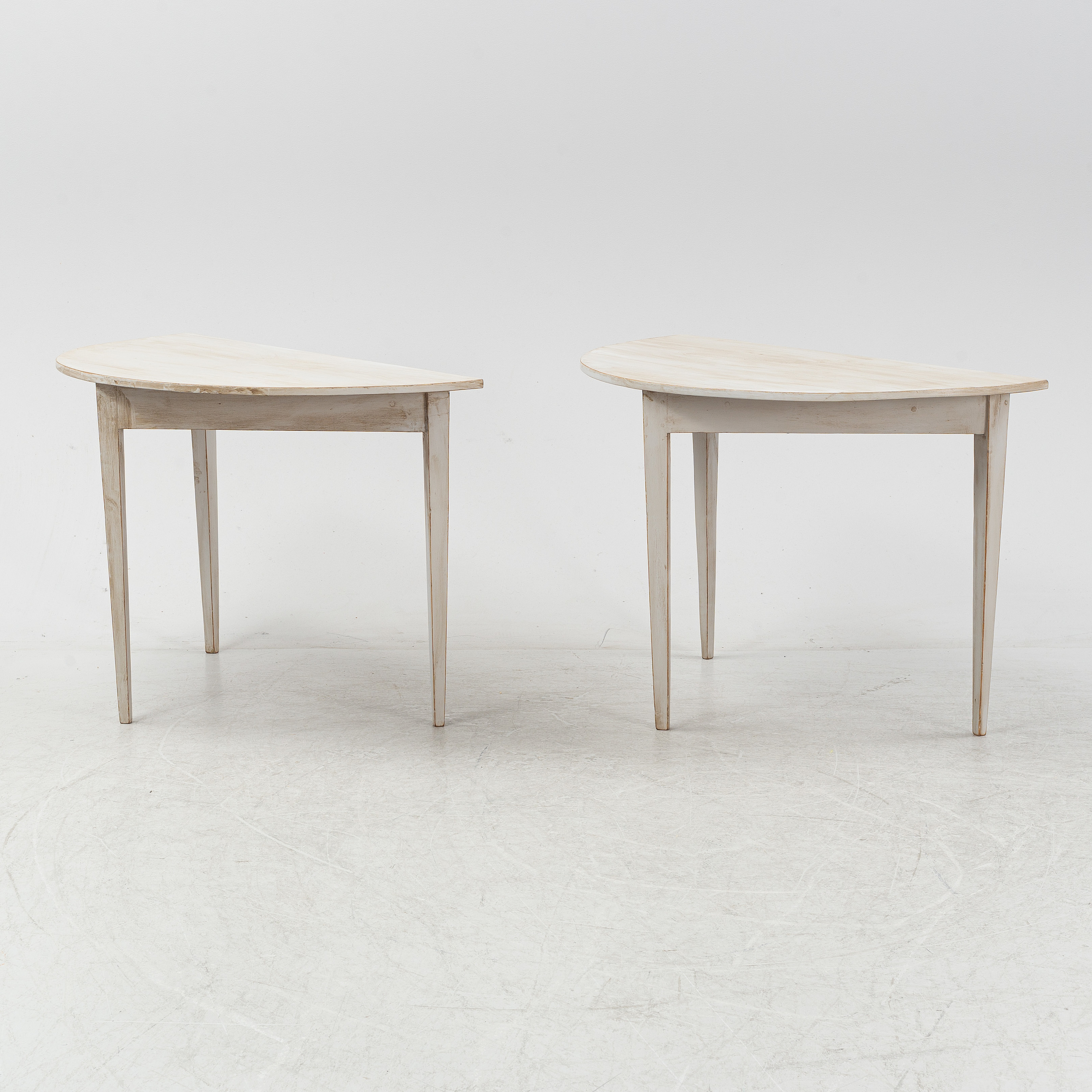 A pair of crescent shaped tables, late 19th century. - Bukowskis