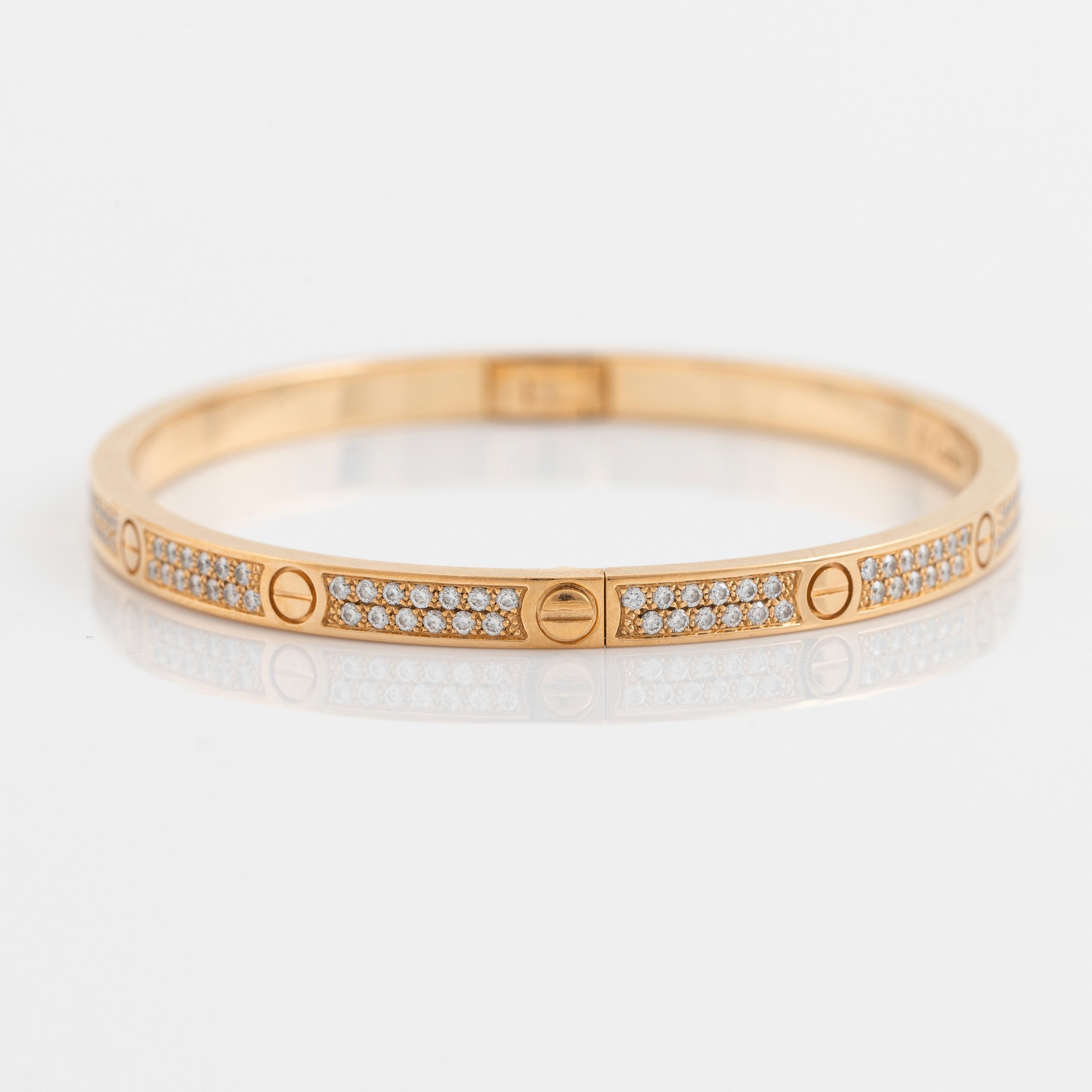 A Cartier "Love" bracelet small model in 18K gold set with round ...