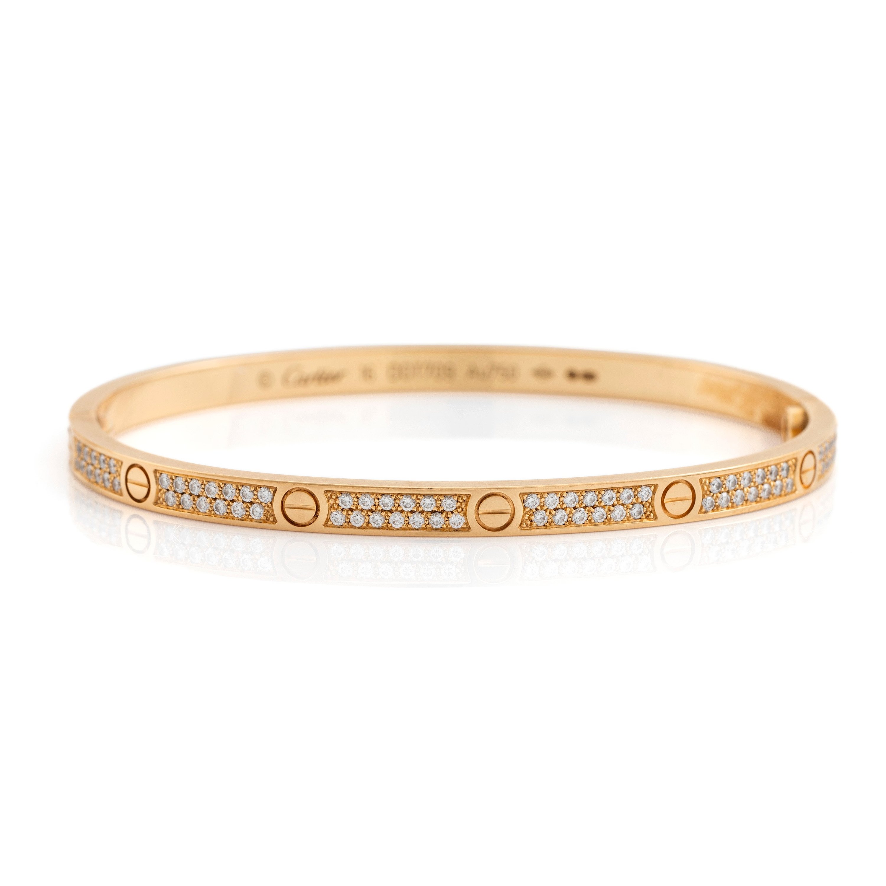 A Cartier "Love" bracelet small model in 18K gold set with round ...