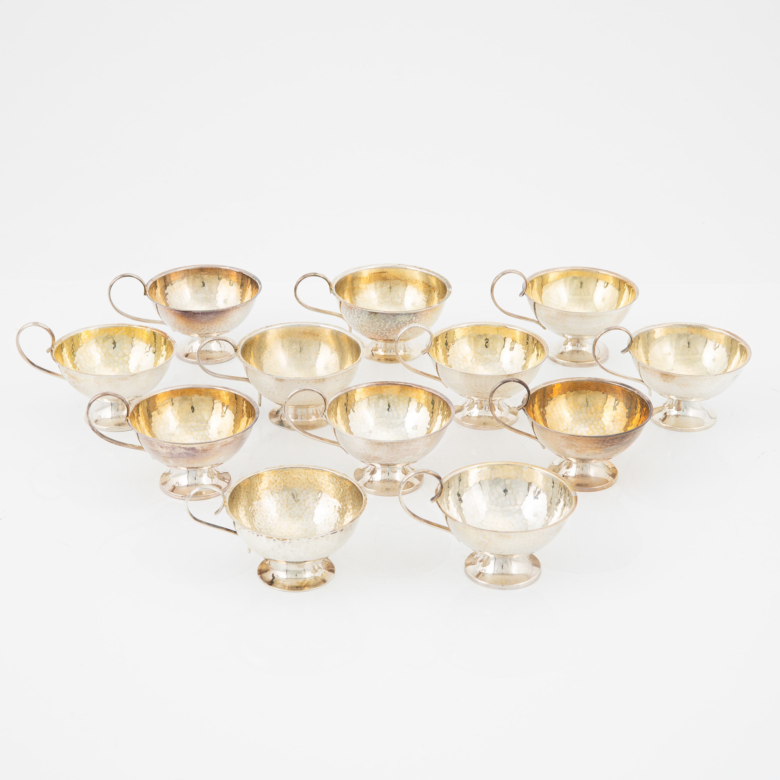 A group of twelve Swedish silver punsch cups, including Ceson Guldvaru ...