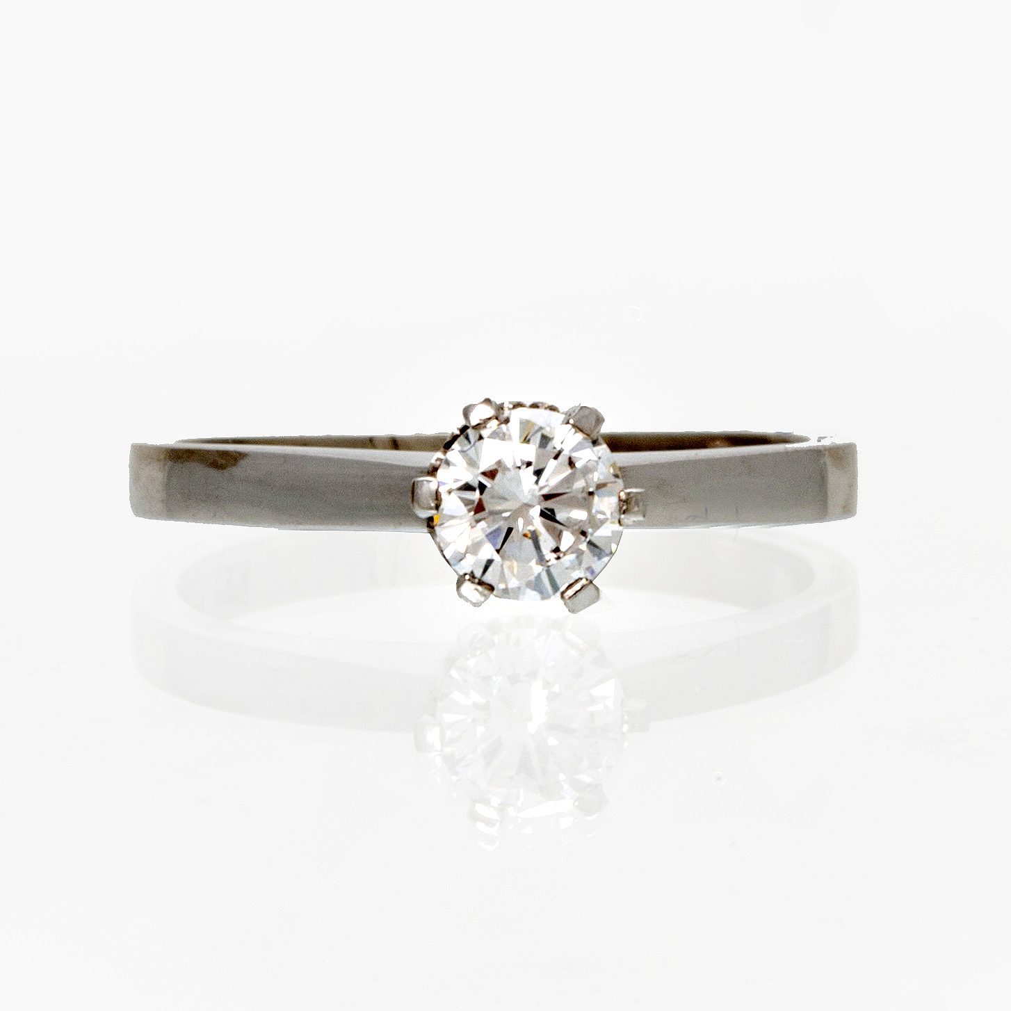 An 18K white gold solitaire ring with a brilliant-cut diamond by ...