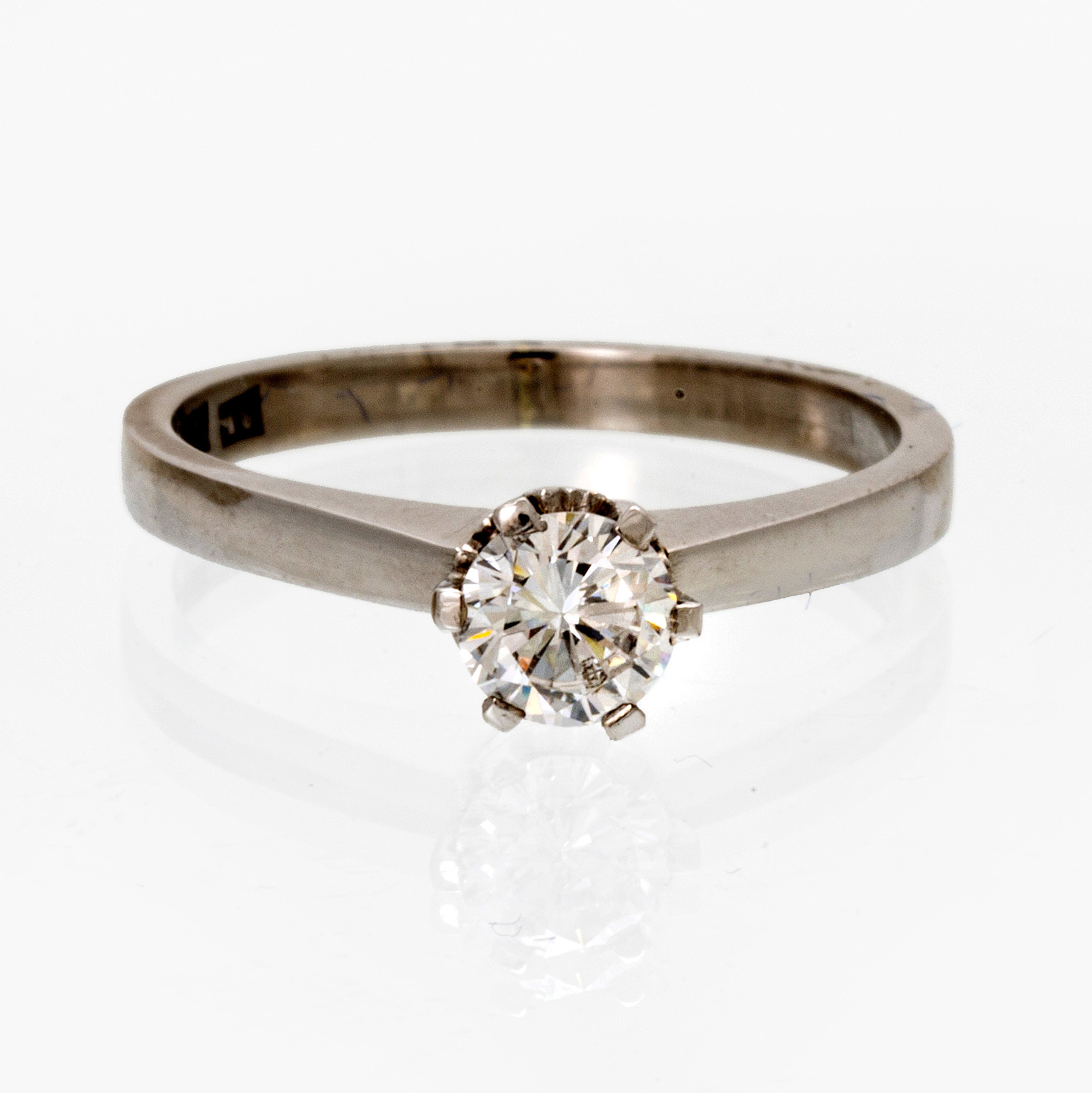 An 18K white gold solitaire ring with a brilliant-cut diamond by ...