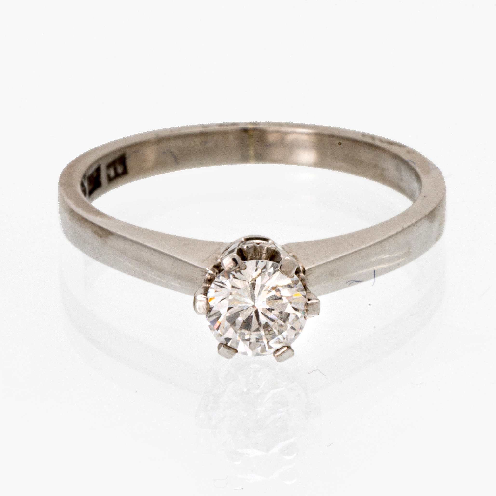 An 18K white gold solitaire ring with a brilliant-cut diamond by ...
