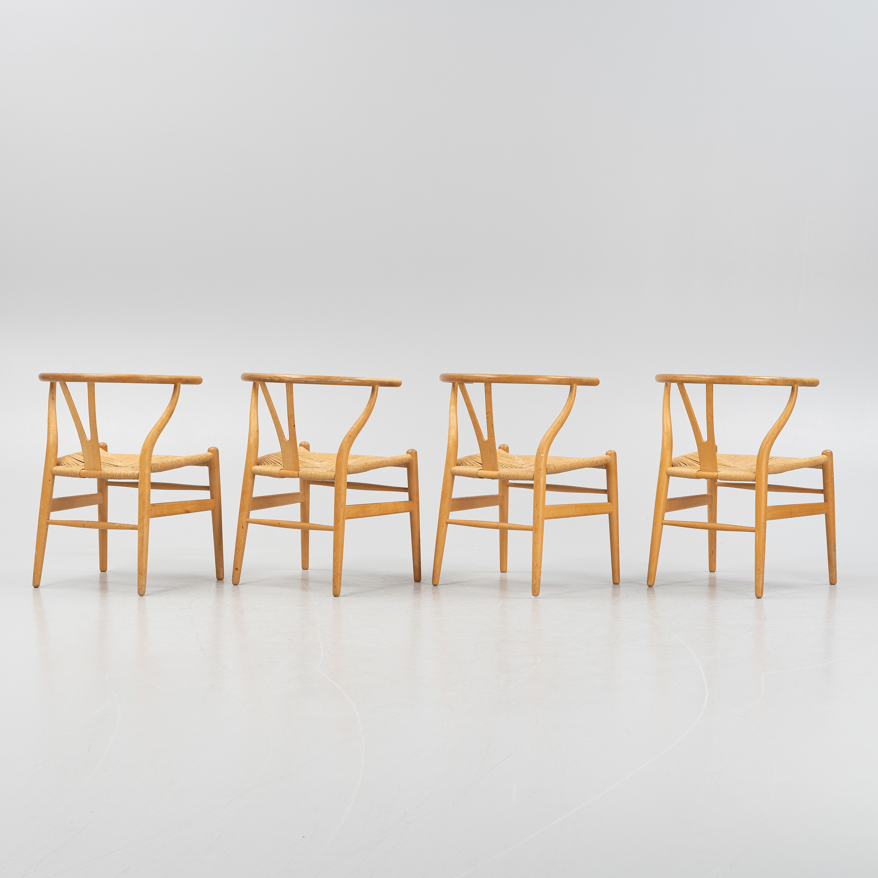Hans J Wegner, a set of four beech 'CH-24' chairs, Carl Hansen & Son ...