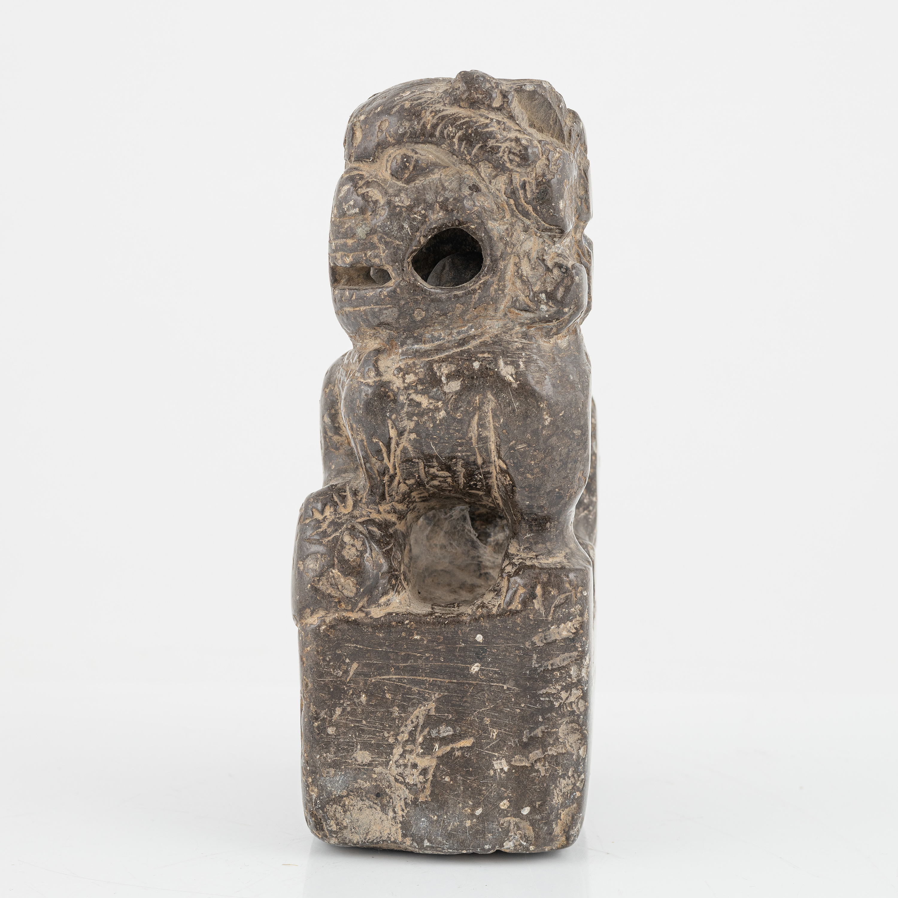 A stone scroll weight/sculpture of a buddhist lion, China, presumably ...