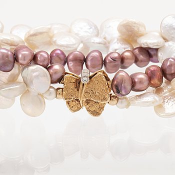 A 14K white and red gold lock with round brilliant cut diamonds and ...