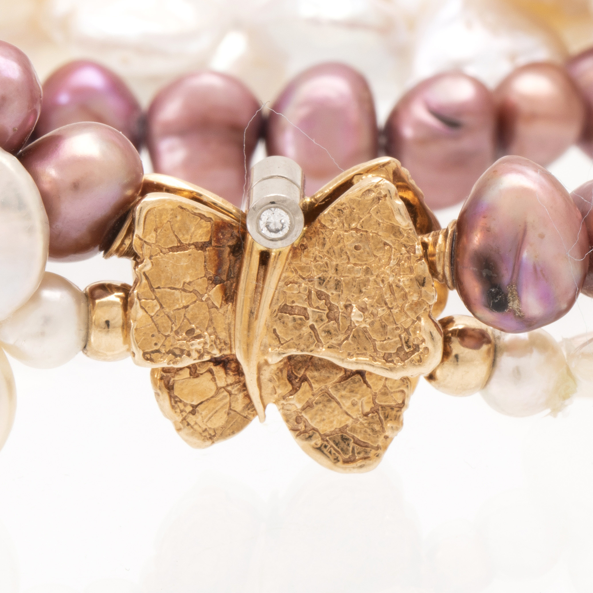 A 14K white and red gold lock with round brilliant cut diamonds and ...