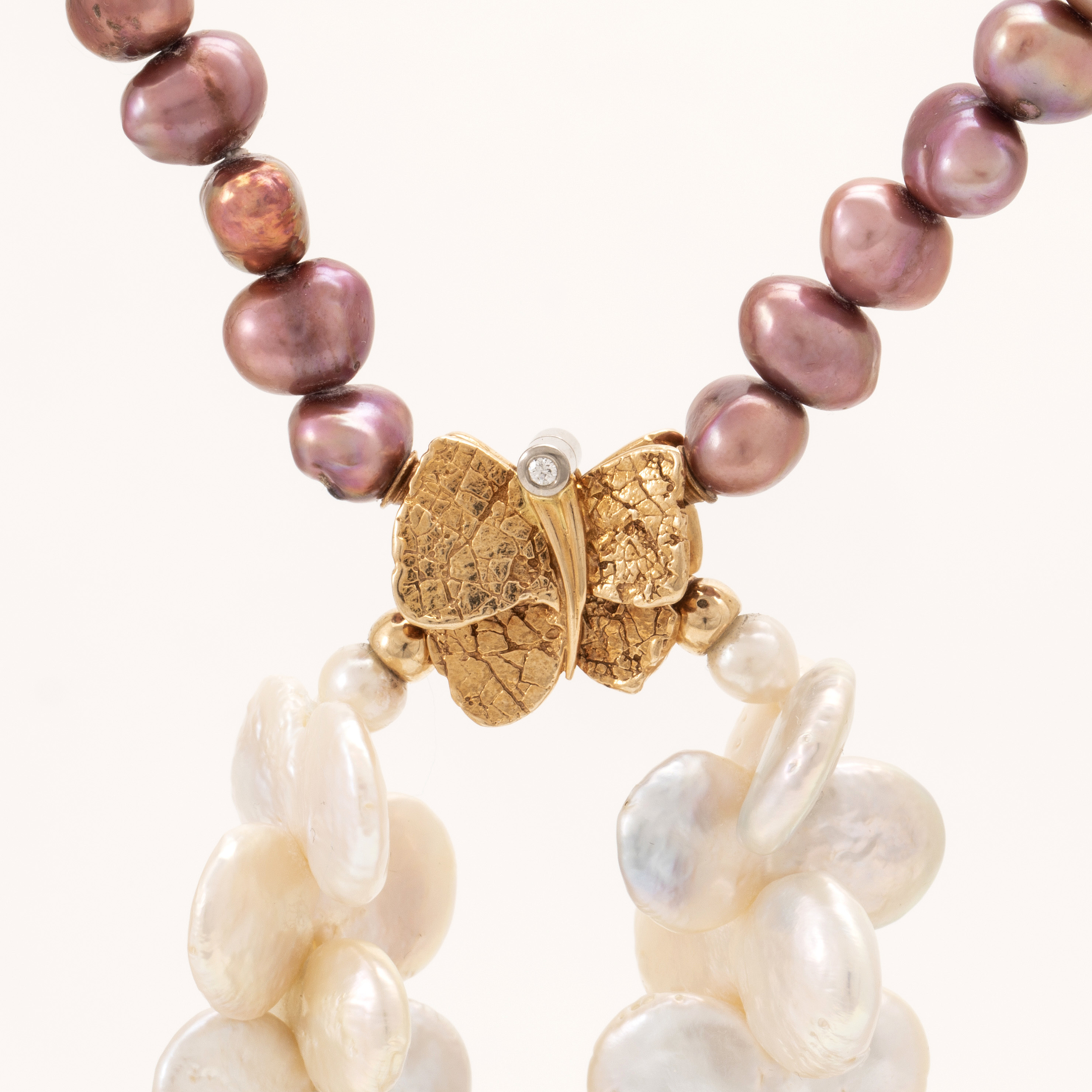 A 14K white and red gold lock with round brilliant cut diamonds and ...