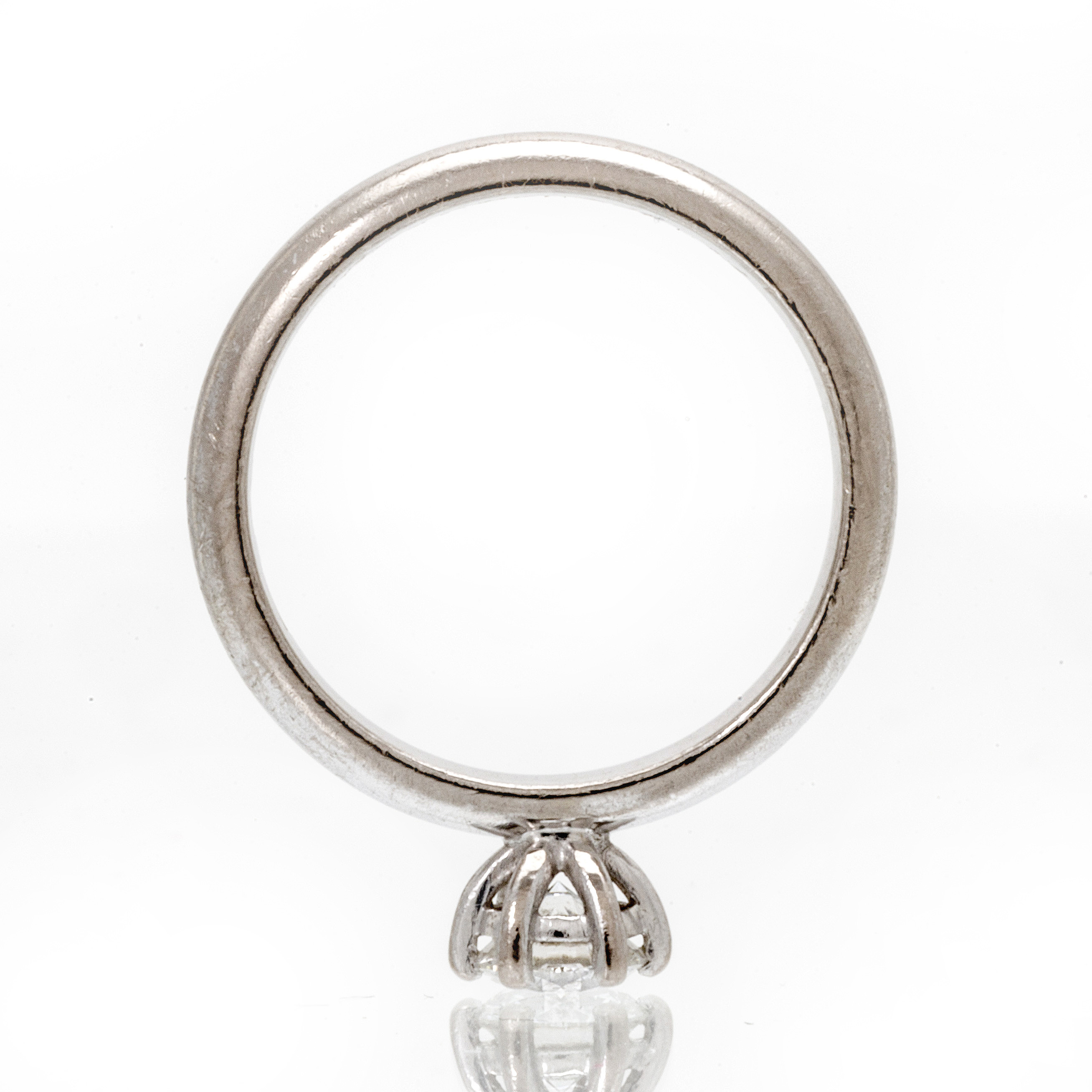 An 18K white gold solitaire ring set with a round brilliant cut diamond ...