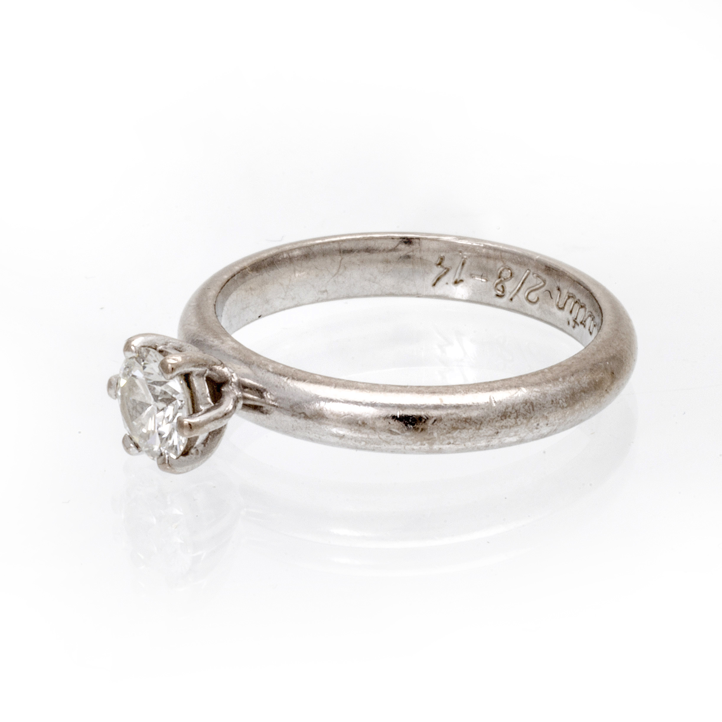 An 18K white gold solitaire ring set with a round brilliant cut diamond ...