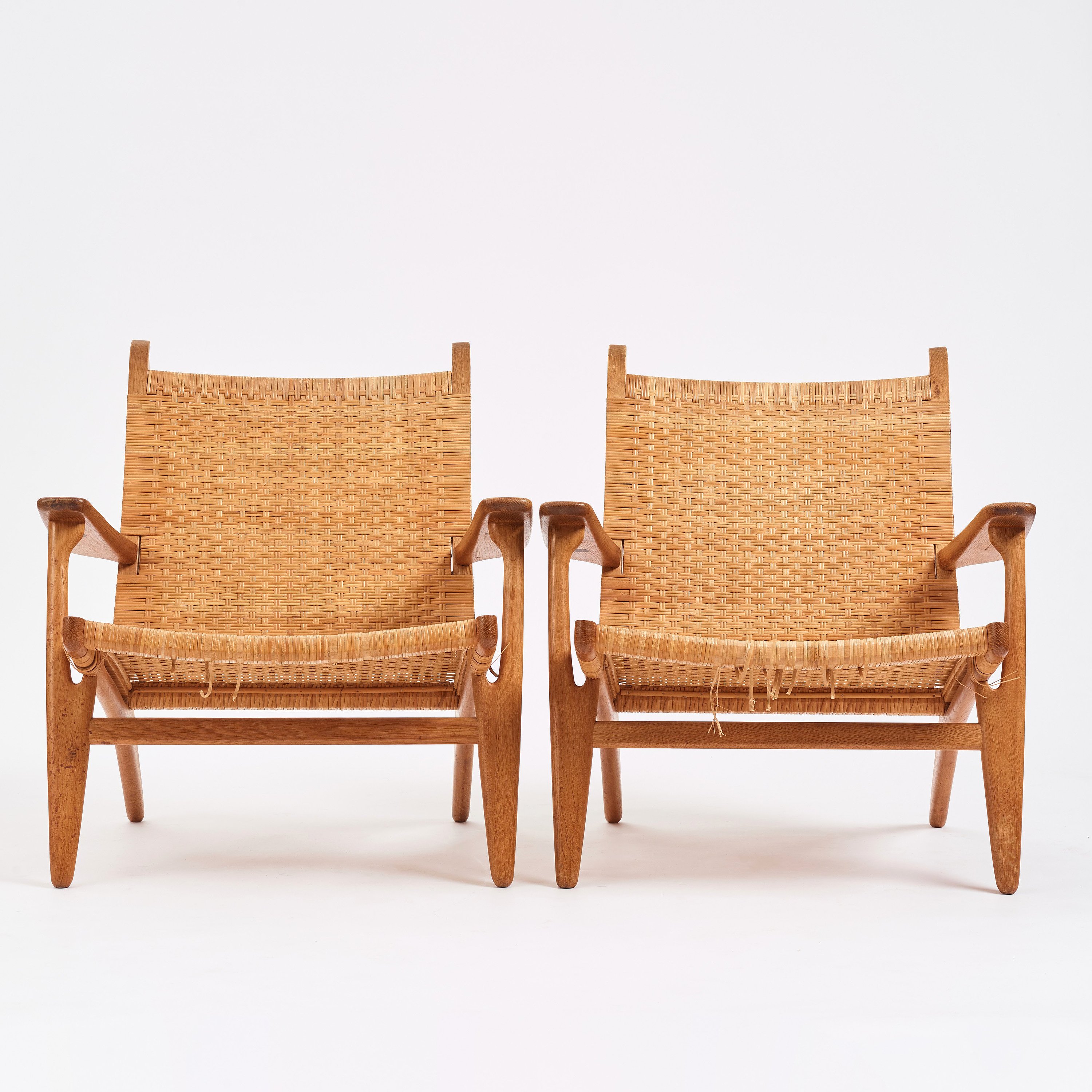 Hans J. Wegner, a pair of oak and rattan 'CH27' chairs, Carl Hansen ...