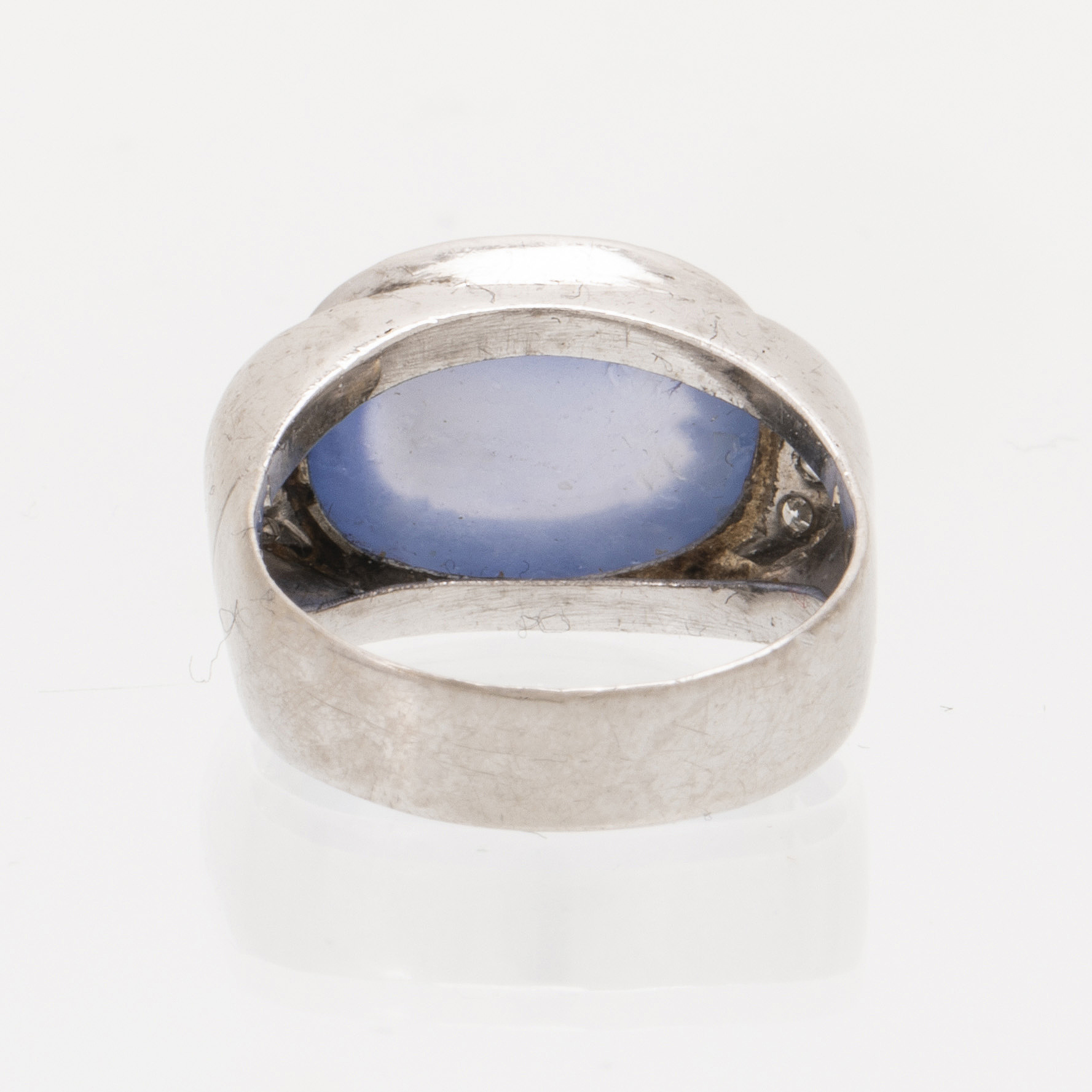 An 18K white gold ring set with single cut diamonds and an oval ...