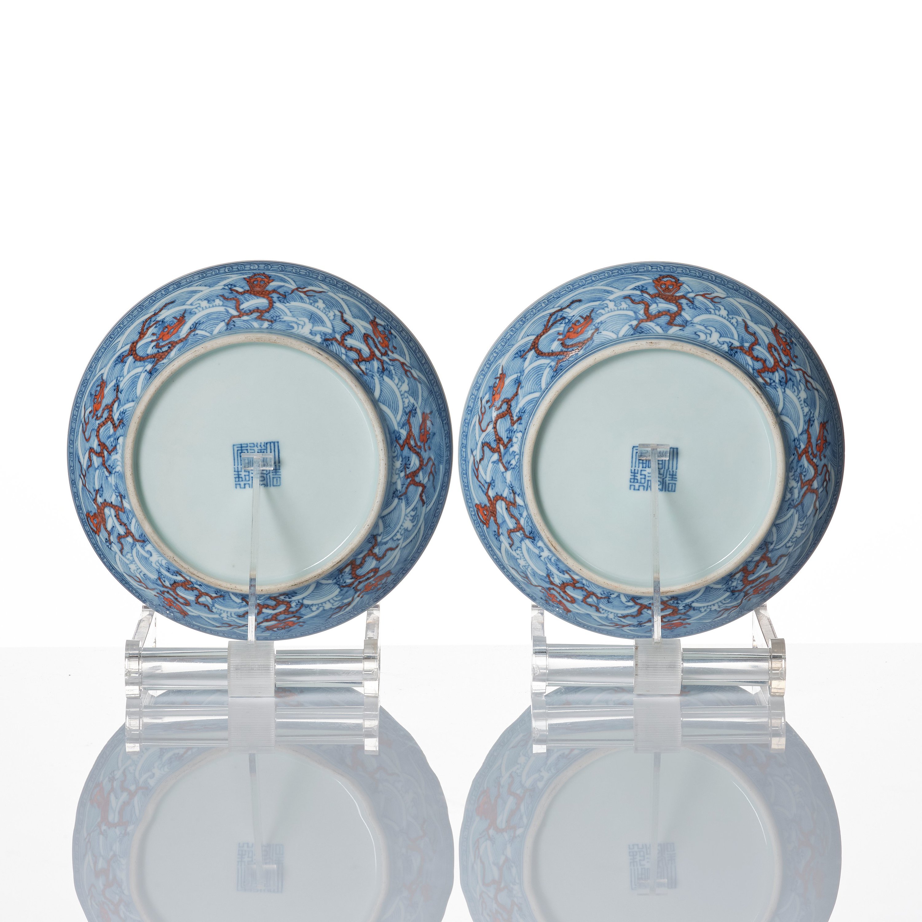 A pair of blue and white and iron red decorated dragon dishes, Qing ...