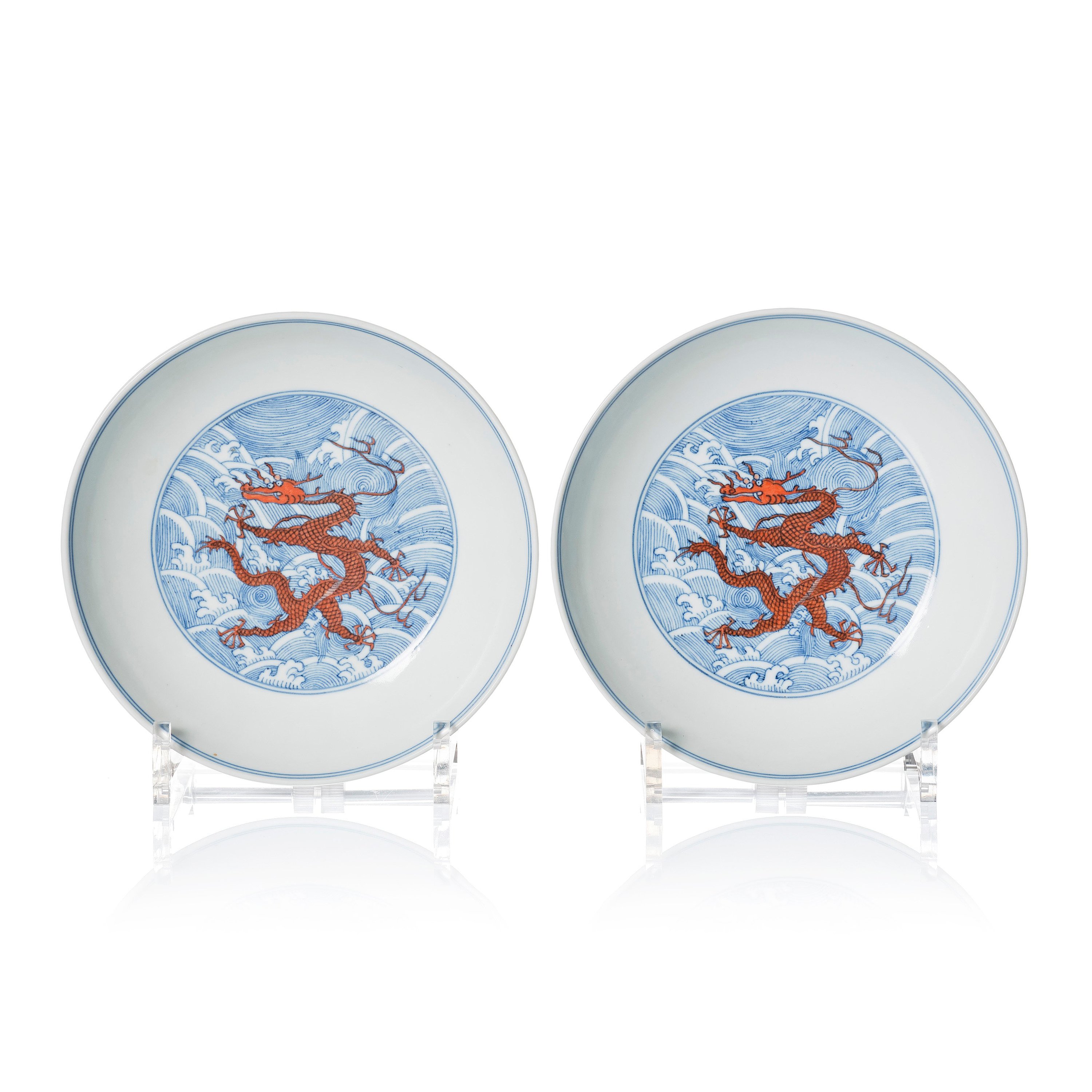 A pair of blue and white and iron red decorated dragon dishes, Qing ...