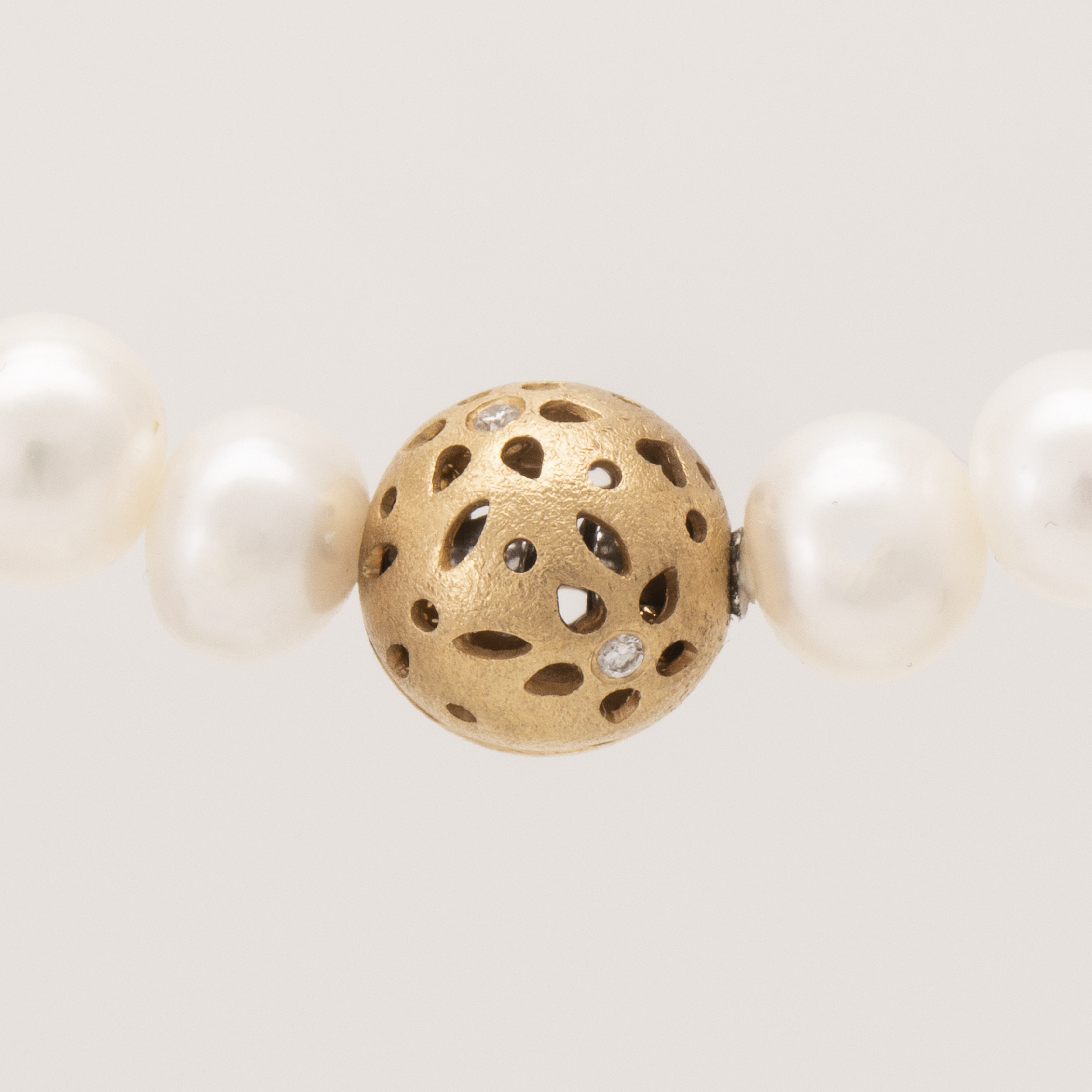 An 18K gold "Lace" lock by Ole Lynggaard set with round brilliant cut ...