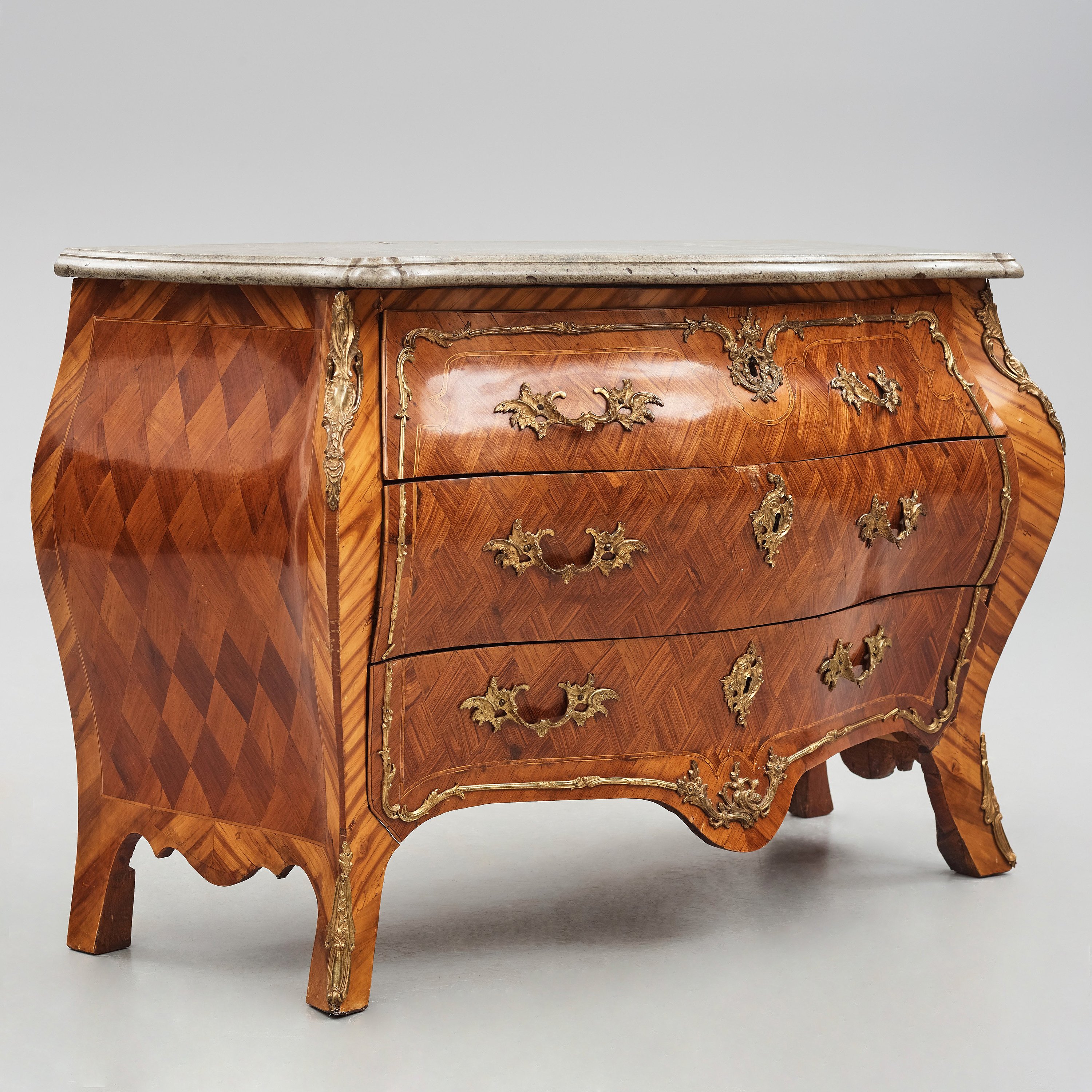 A rococo rosewood-veneered and ormolu-mounted commode by N. Korp ...
