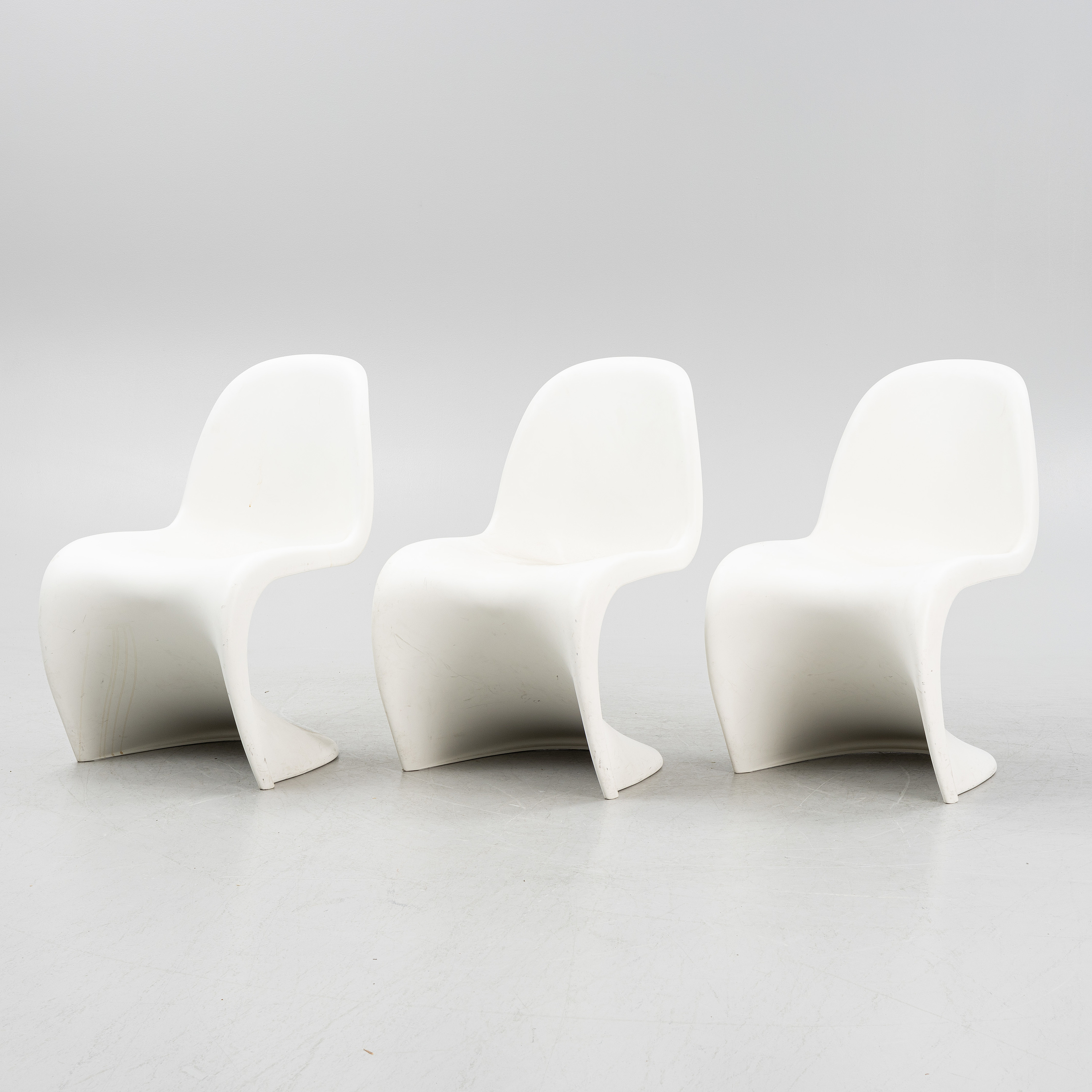 Verner Panton, three white plastic 'Panton Chair Classic', chairs ...