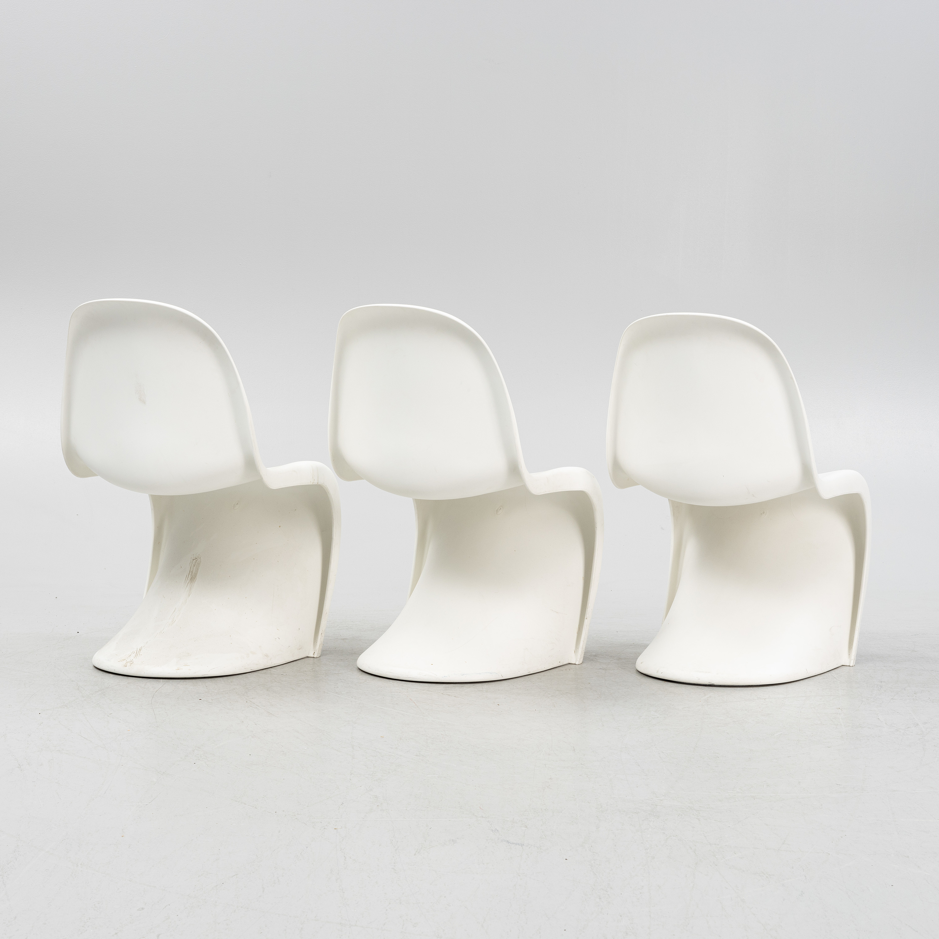 Verner Panton, three white plastic 'Panton Chair Classic', chairs ...