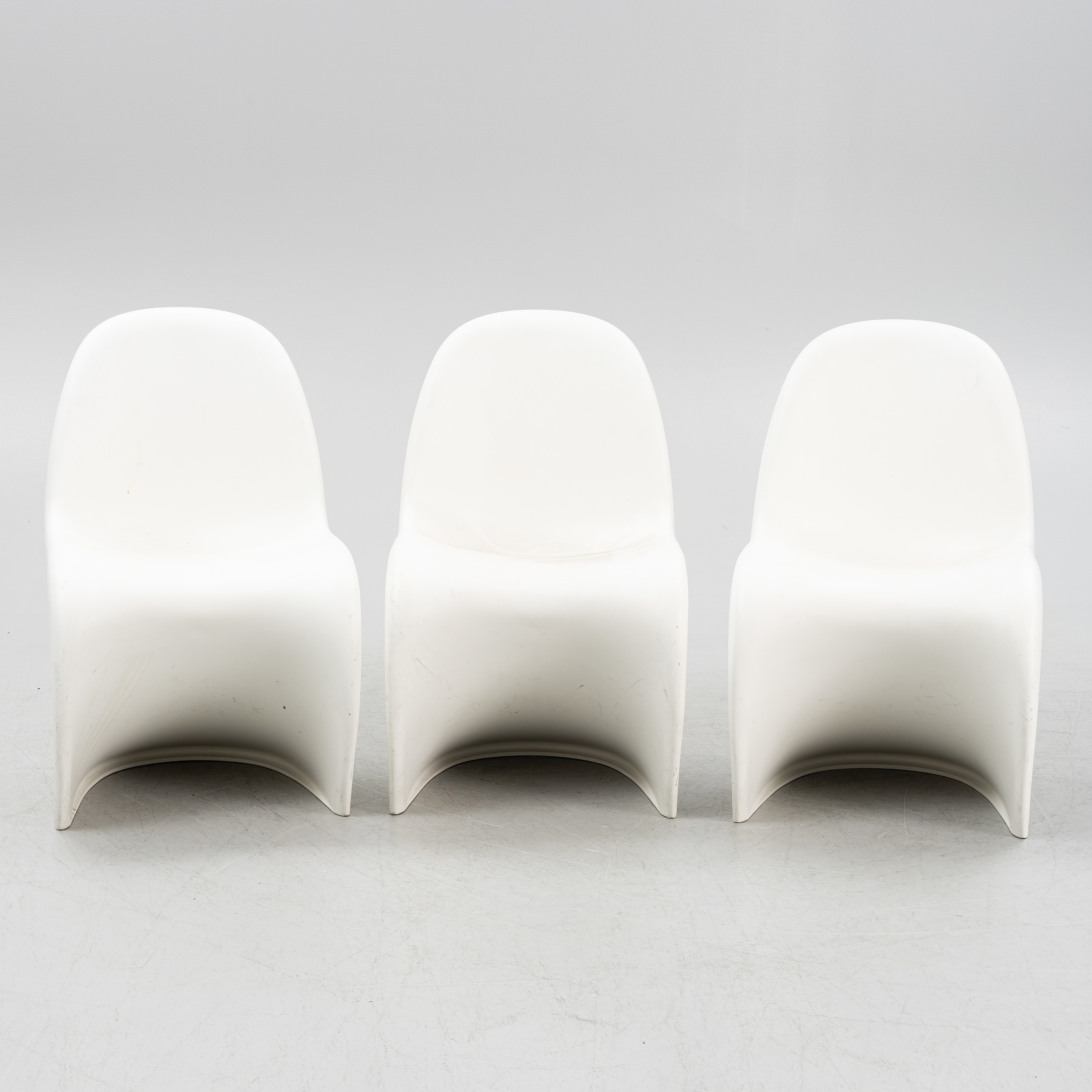 Verner Panton, three white plastic 'Panton Chair Classic', chairs ...