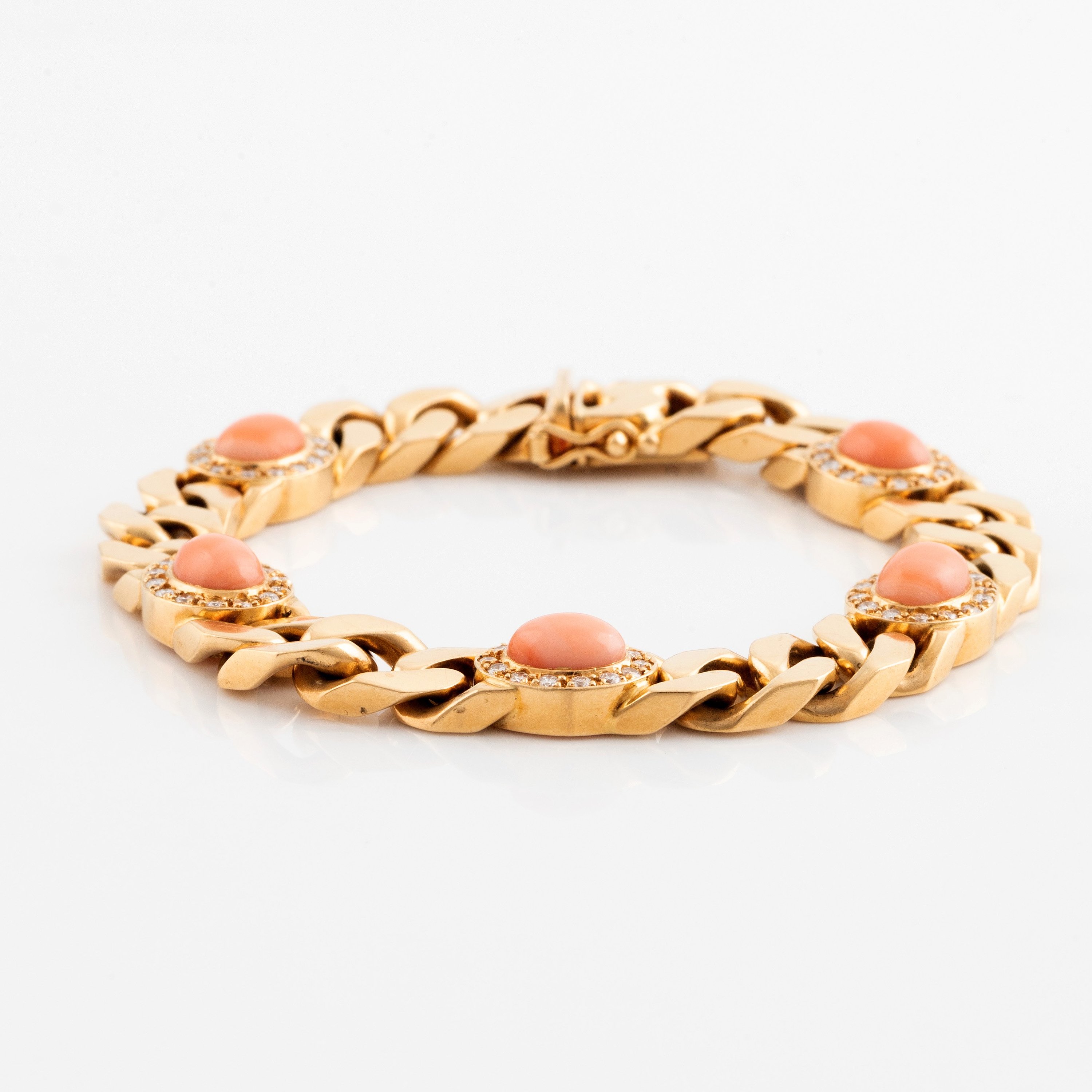 A Bucherer bracelet in 18K gold set with coral and round brilliant-cut ...