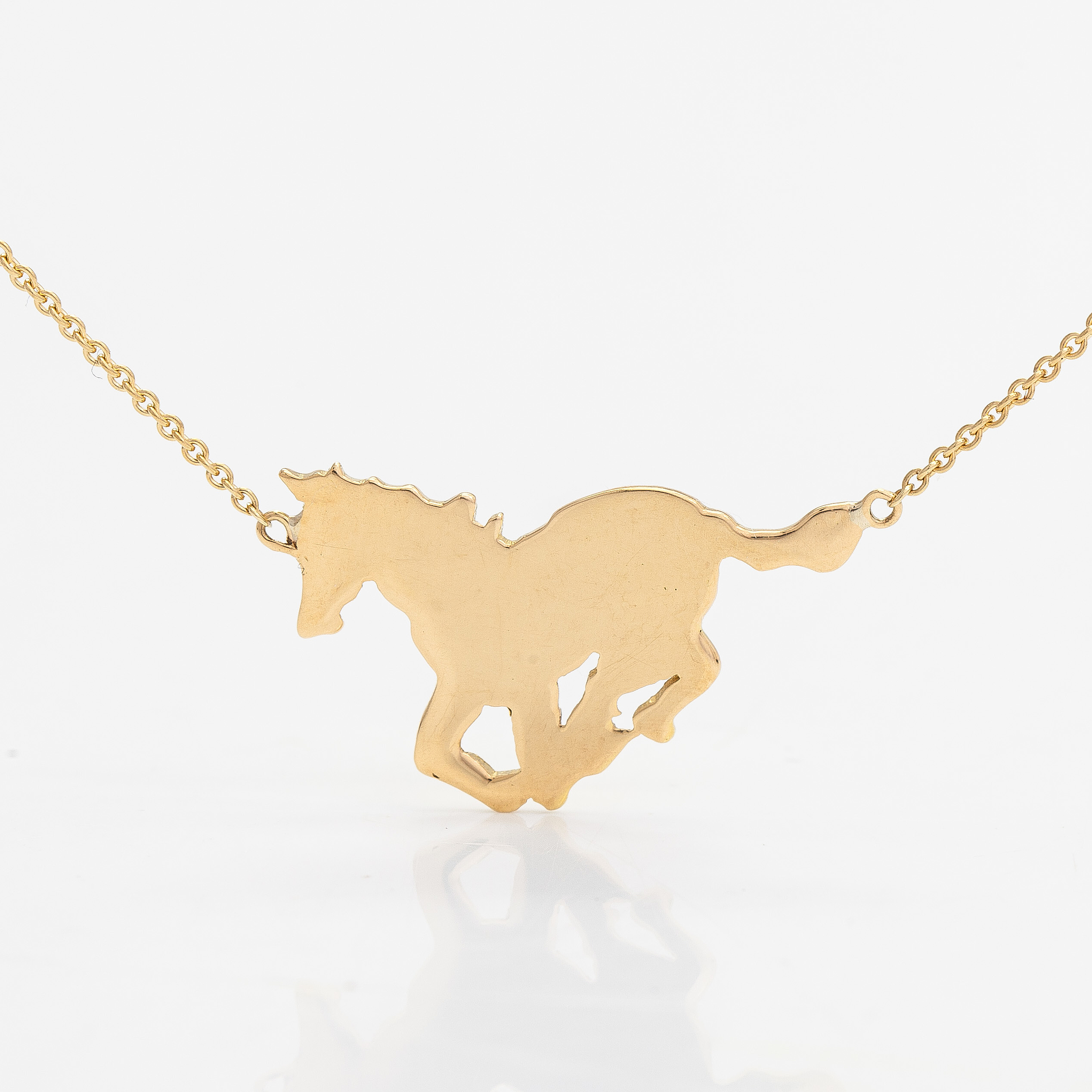 An 18K gold horse necklace. Tillander, Helsinki. - Bukowskis