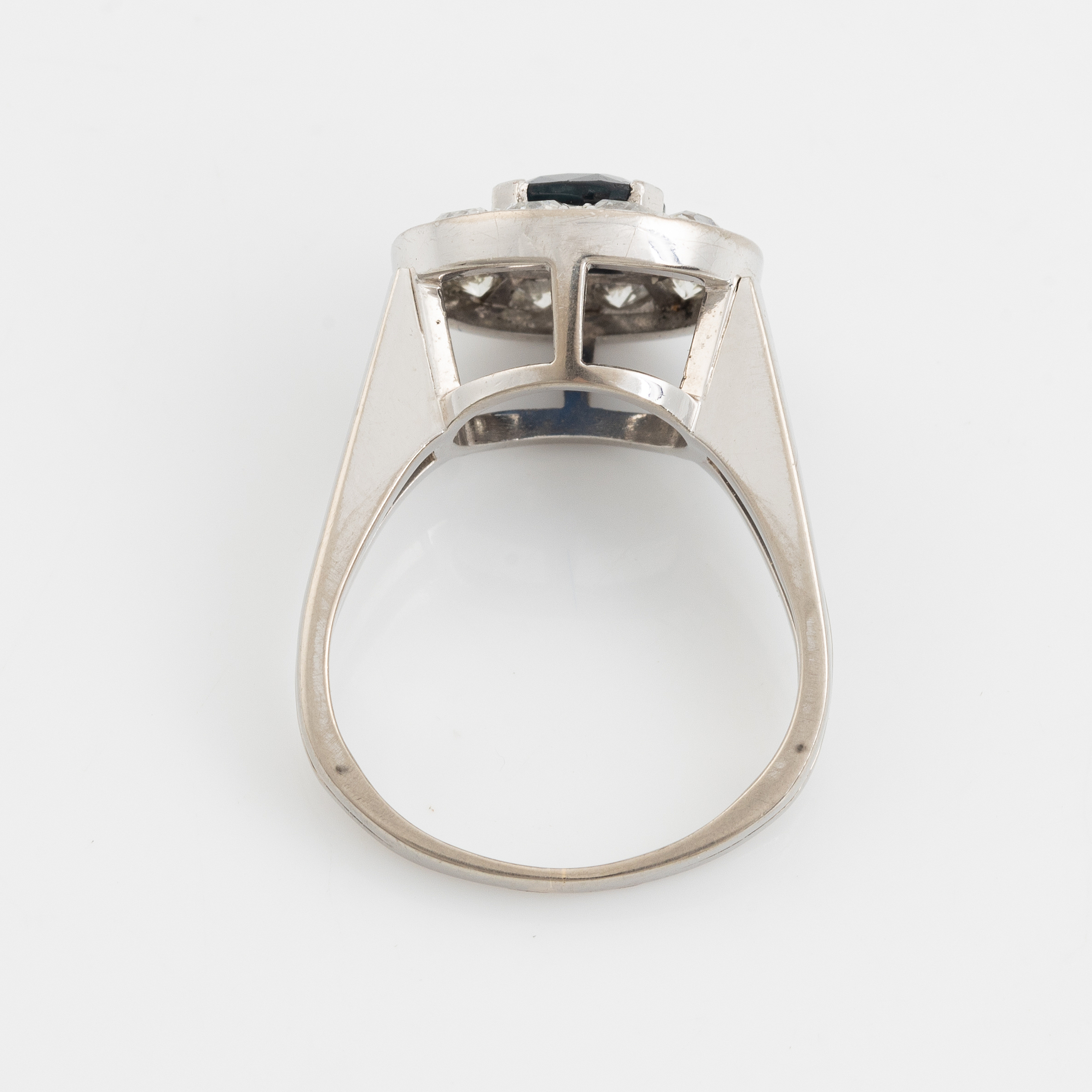 An 18K white gold Rey Urban ring set with a faceted sapphire and old ...