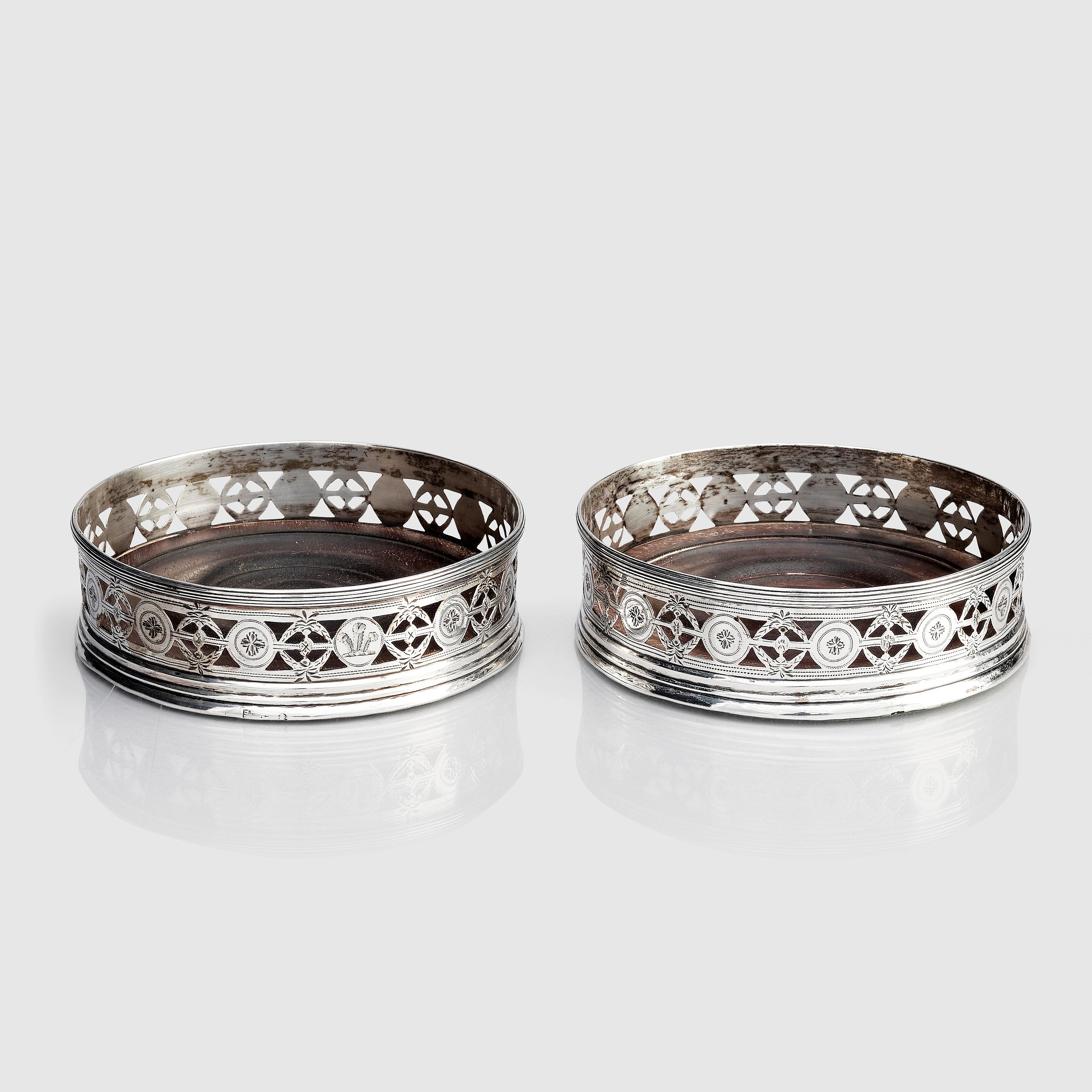 An English late 18th century pair of silver coasters, mark of John ...