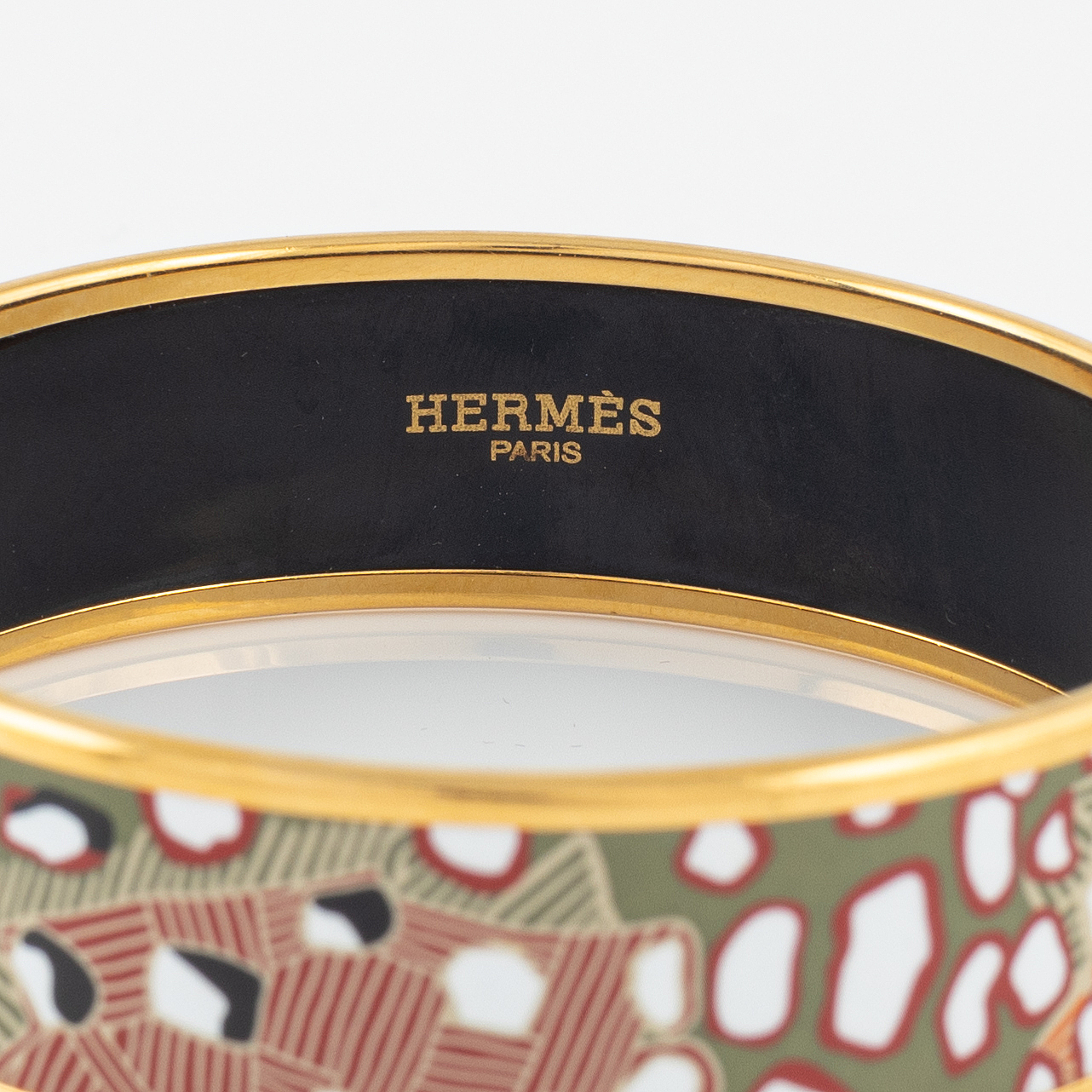 Hermès, an enamel and gold plated metal bangle. - Bukowskis