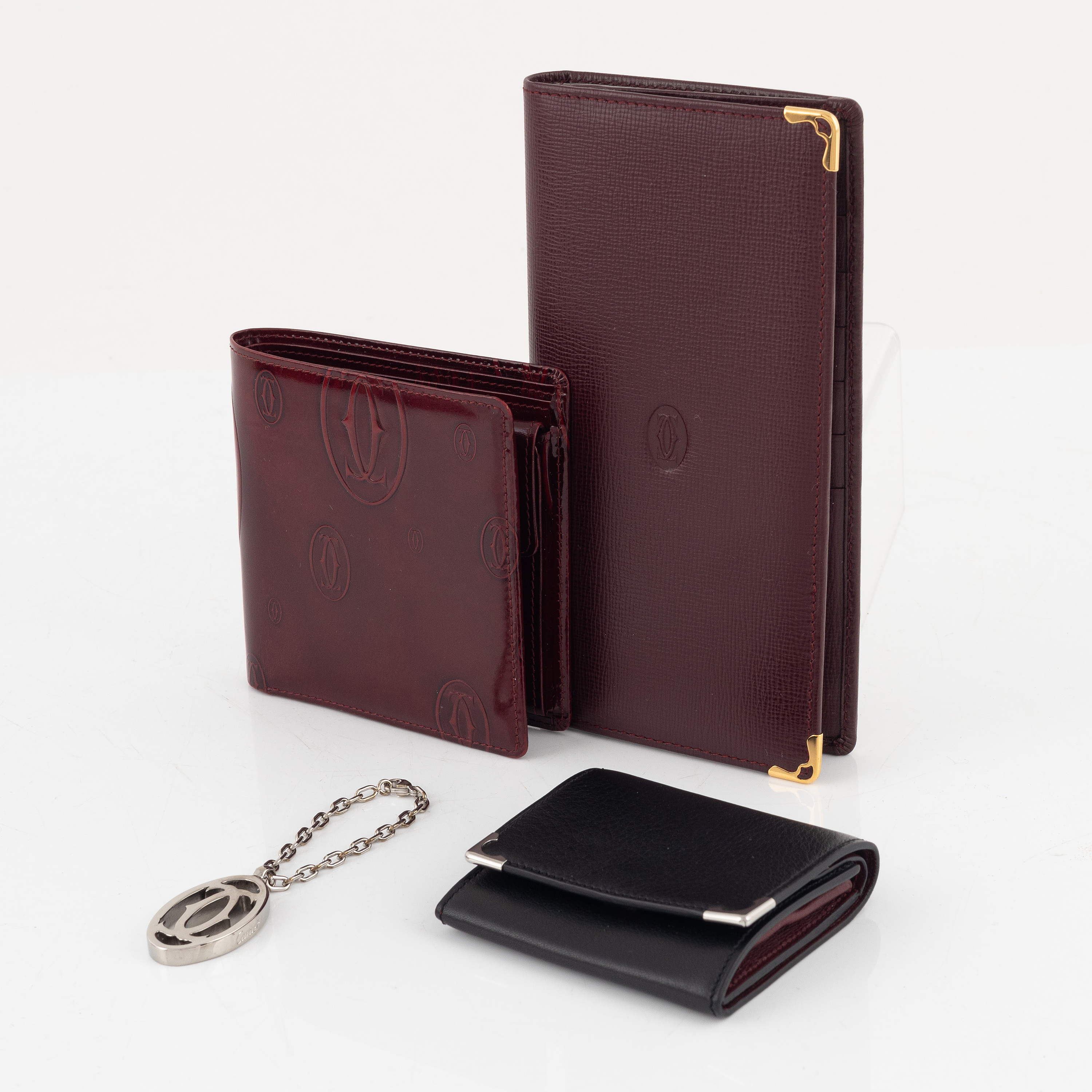 Cartier, three wallets and a key ring. - Bukowskis